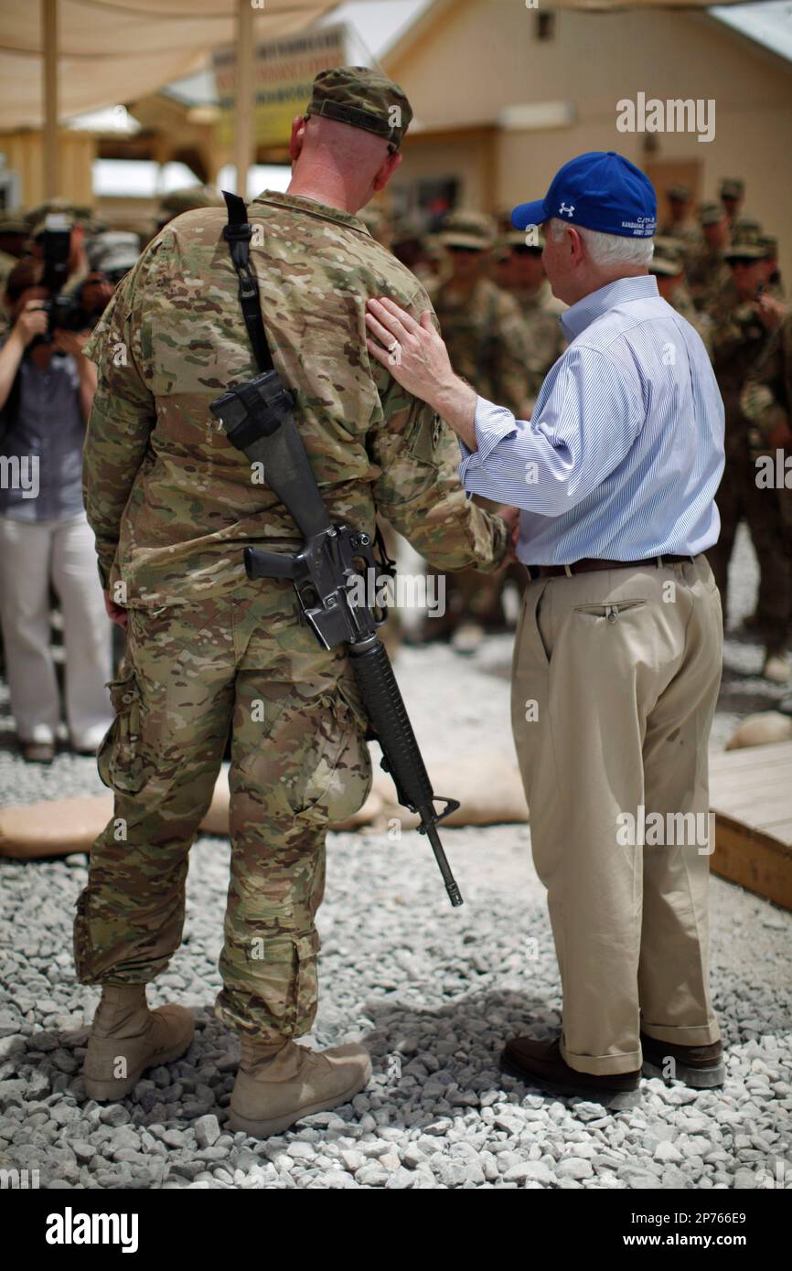 U.S. Secretary of Defense Robert Gates, right, poses for a picture with ...