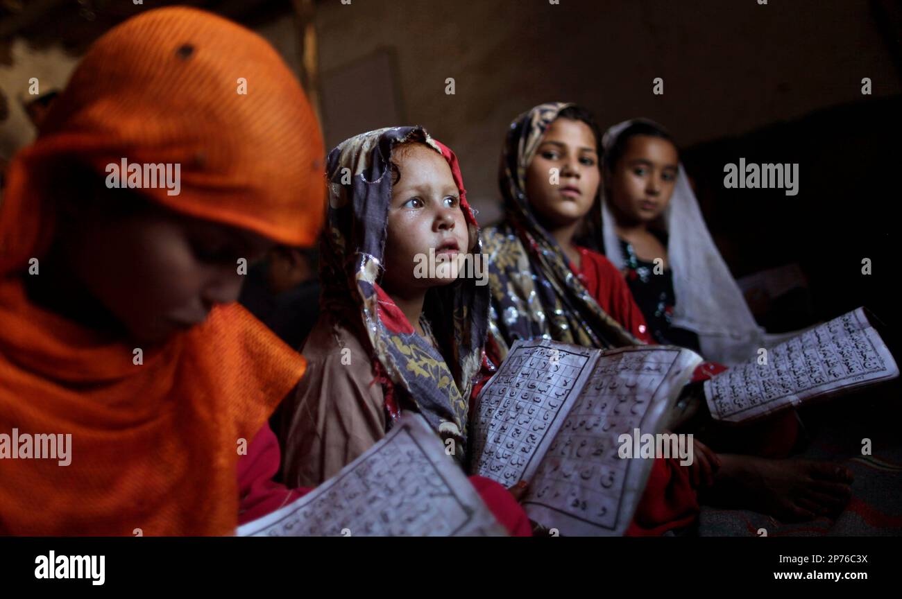 Pakistani Fatima Bekhtyar, 3, center, attends an Islamic religious ...