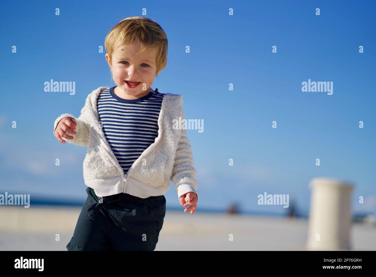 Toddler with Blue Background, Smiling Stock Photo - Alamy