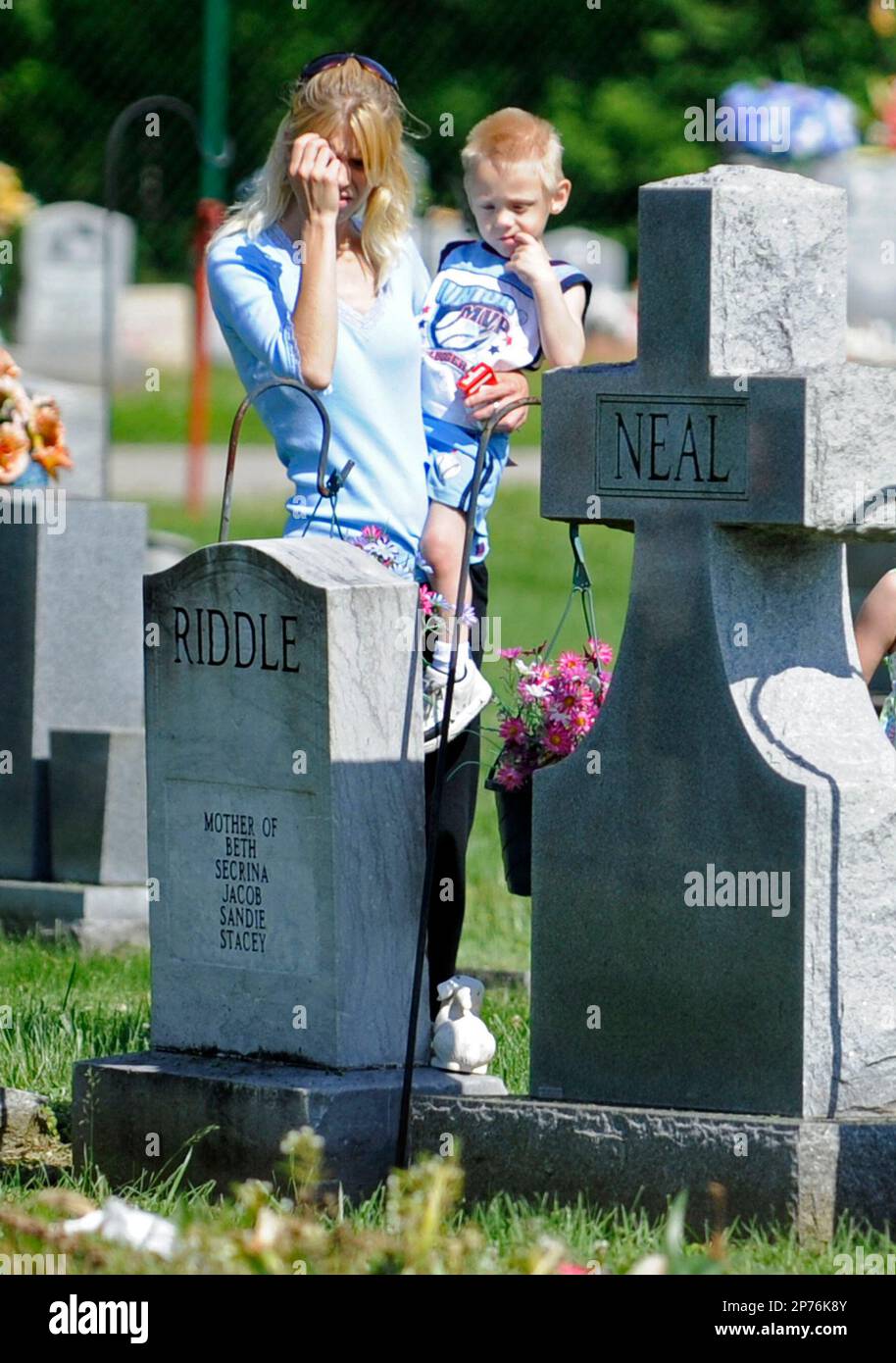 Sandy Riddle, of Bowling Green, Ky., pauses at the grave of her mother ...
