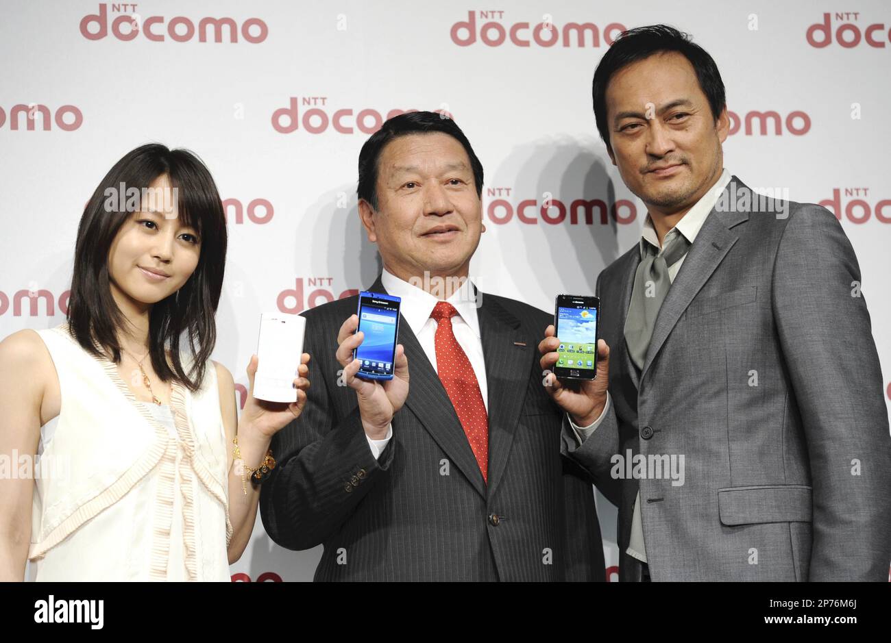 (R-L) Actor Ken Watanabe, Takamochi Yamada, president of NTT and actress Maki Horikita pose for ...