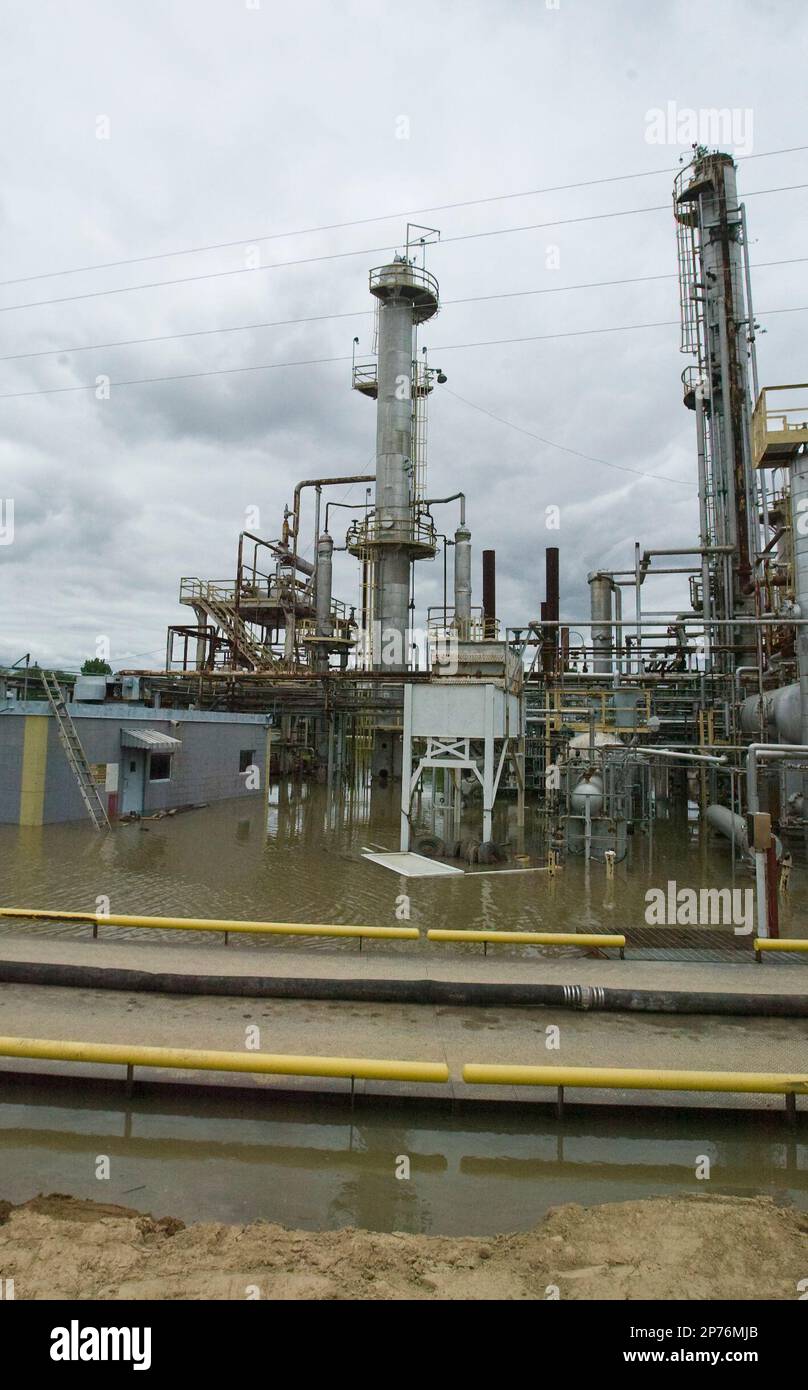 An unused refinery is flooded after a levee built by Warren Paving and ...