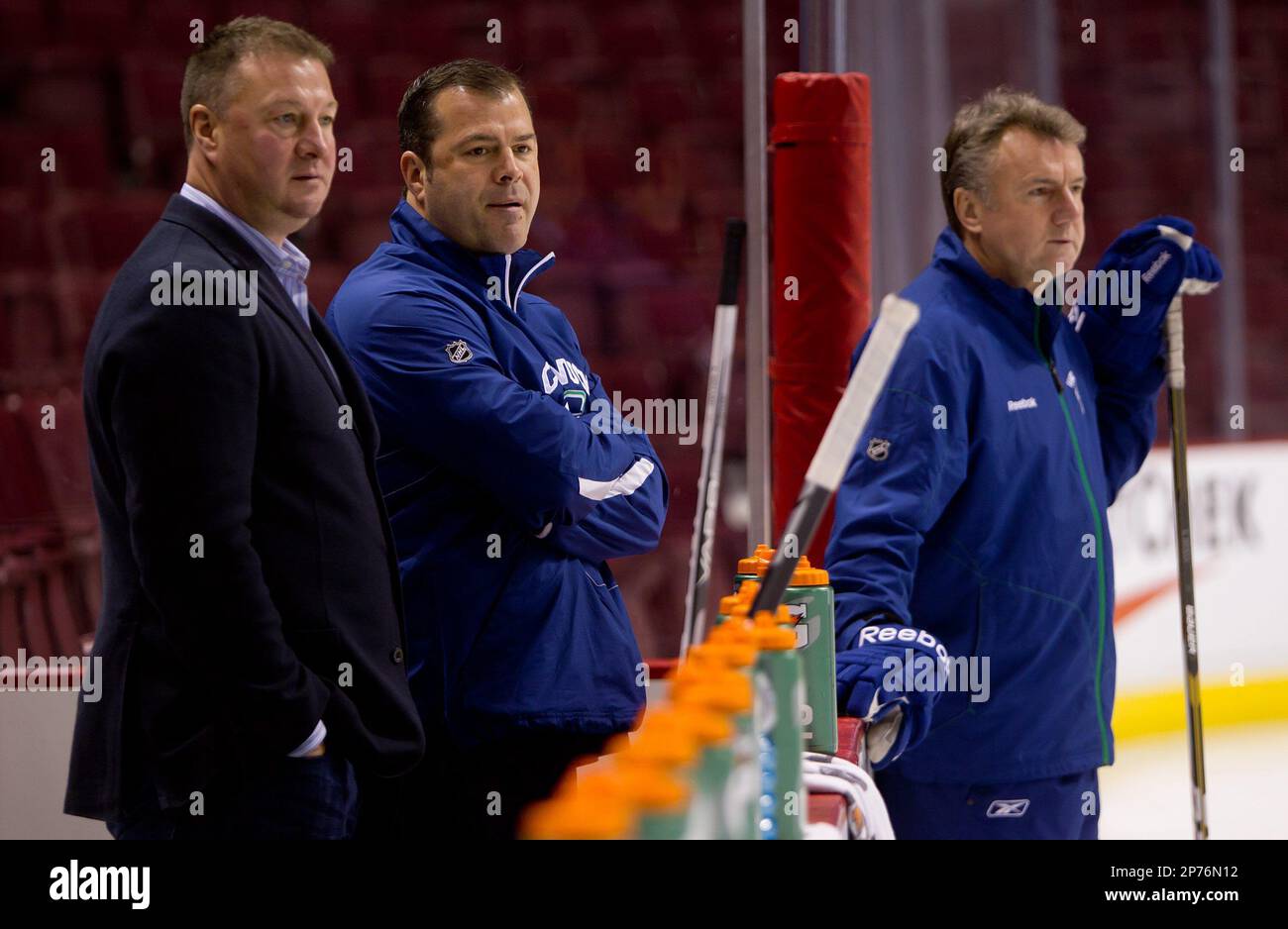Vancouver Canucks' General Manager Mike Gillis, left, and head coach ...