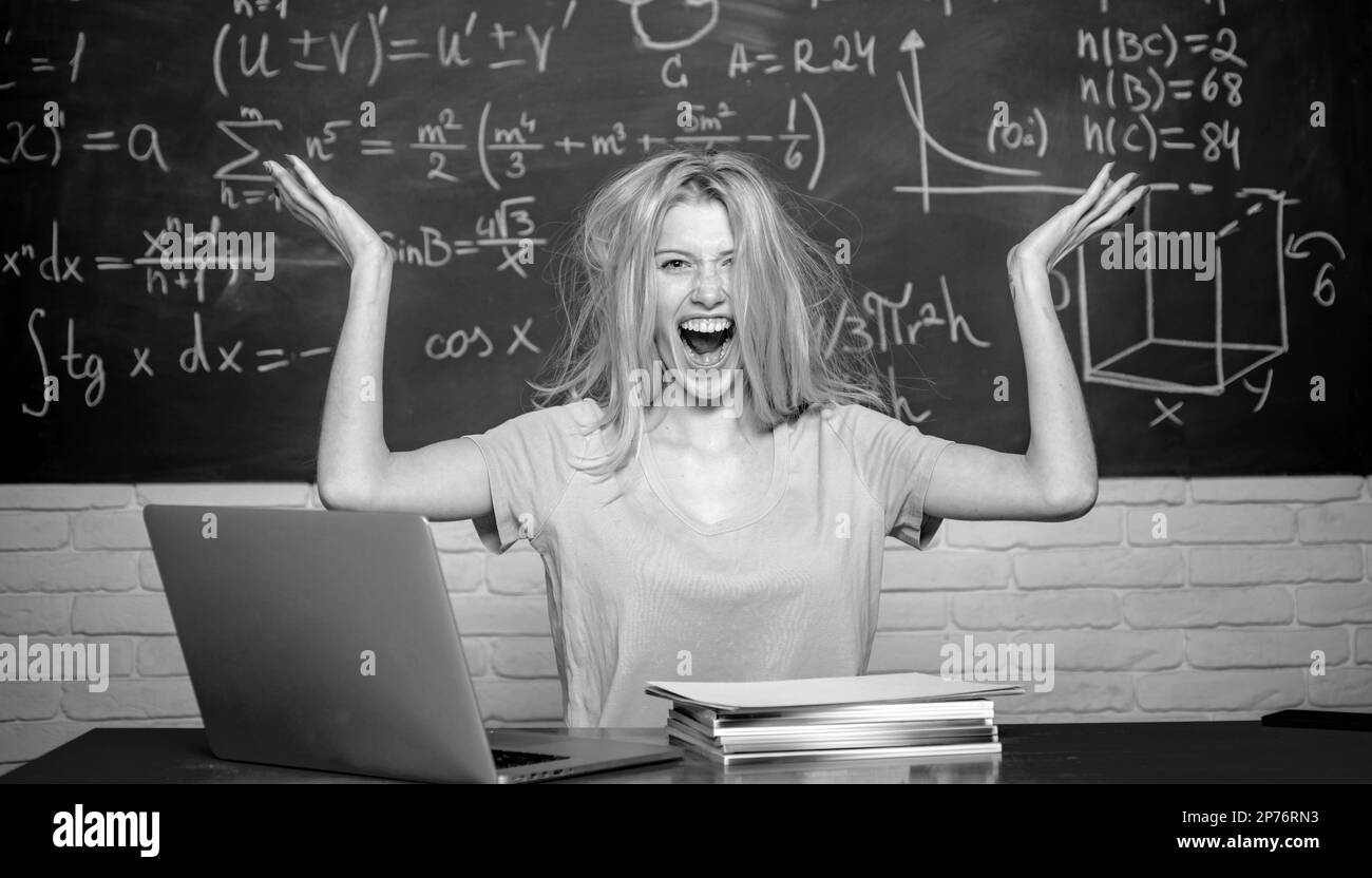 Bored student doing homework on line with a laptop. Student tired of ...