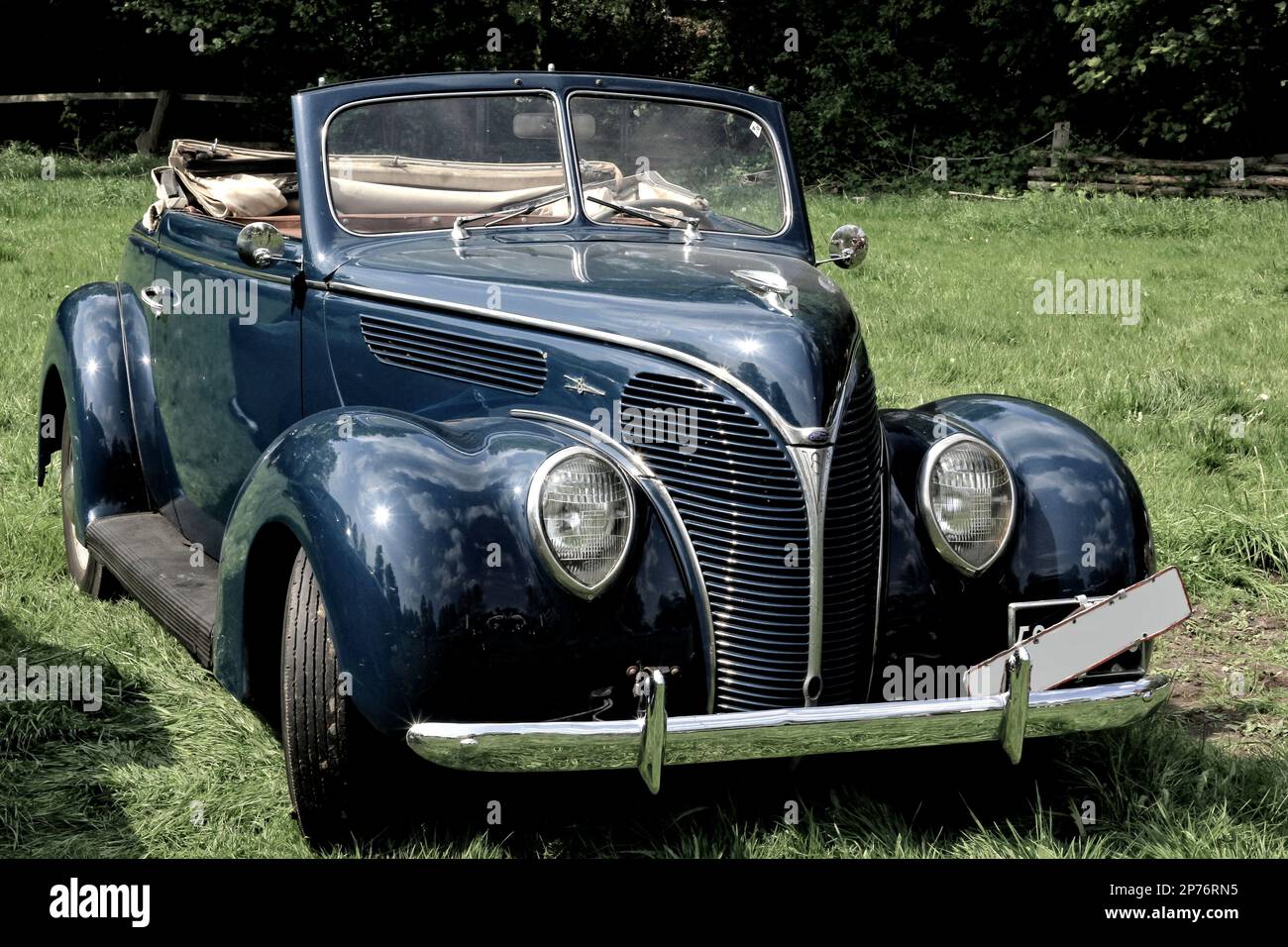 A vintage dark blue Ford car parked in a meadow Stock Photo - Alamy
