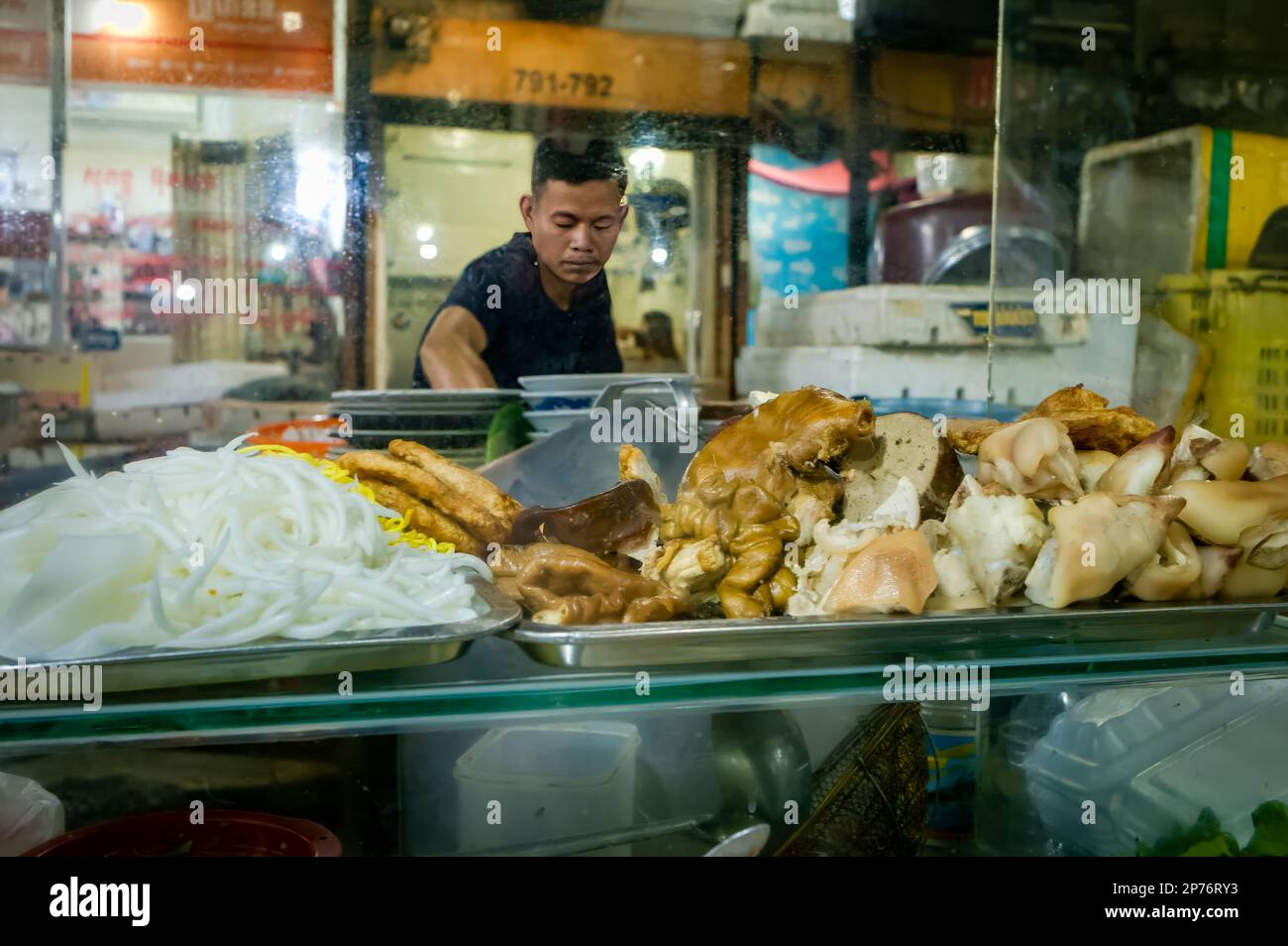 A stallholder prepares food mostly made from pigs trotters and pig ...