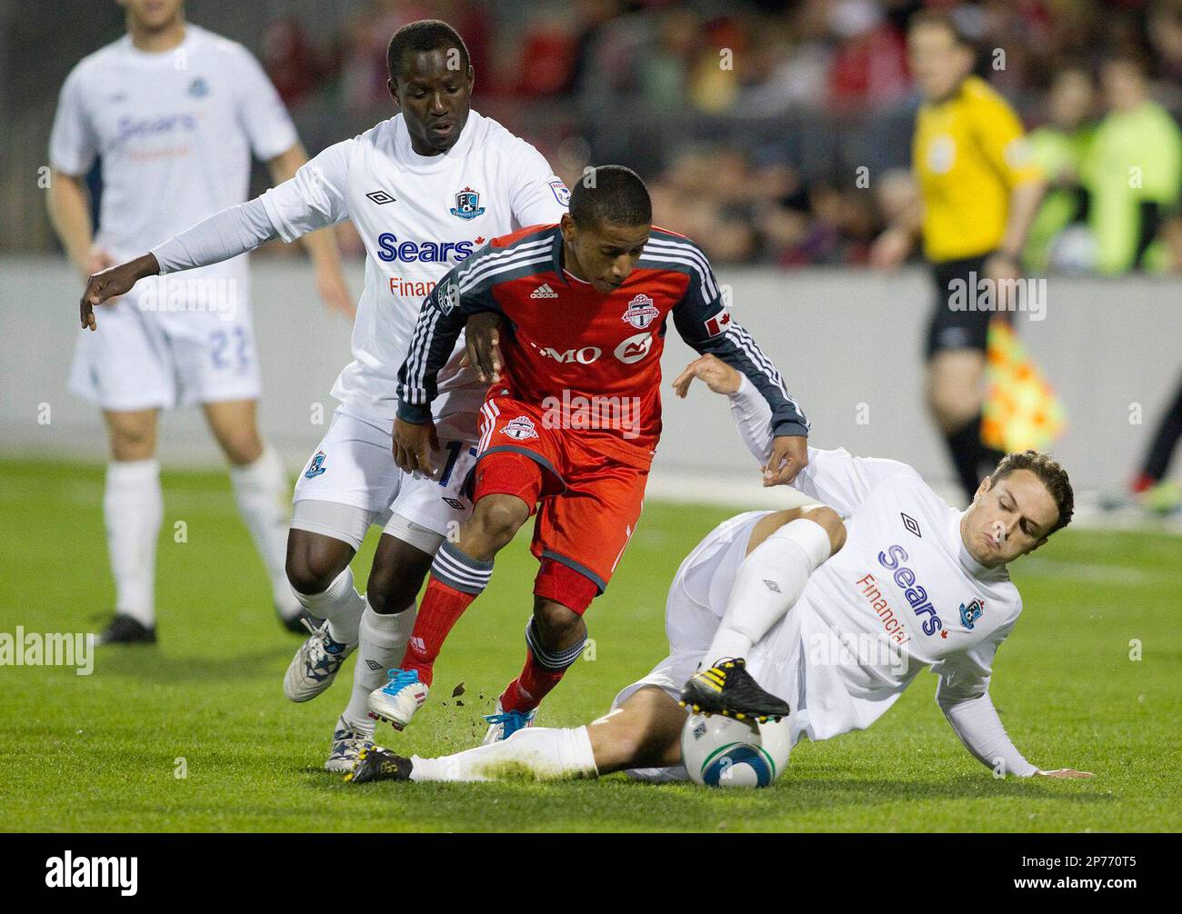 FC Edmonton's Antonio Rago, right, halts the run of Toronto FC 's Joao ...