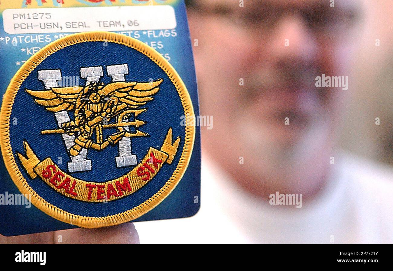 Outdoor Army-Navy store owner Bill Hyland displays the U.S. Navy Seal ...
