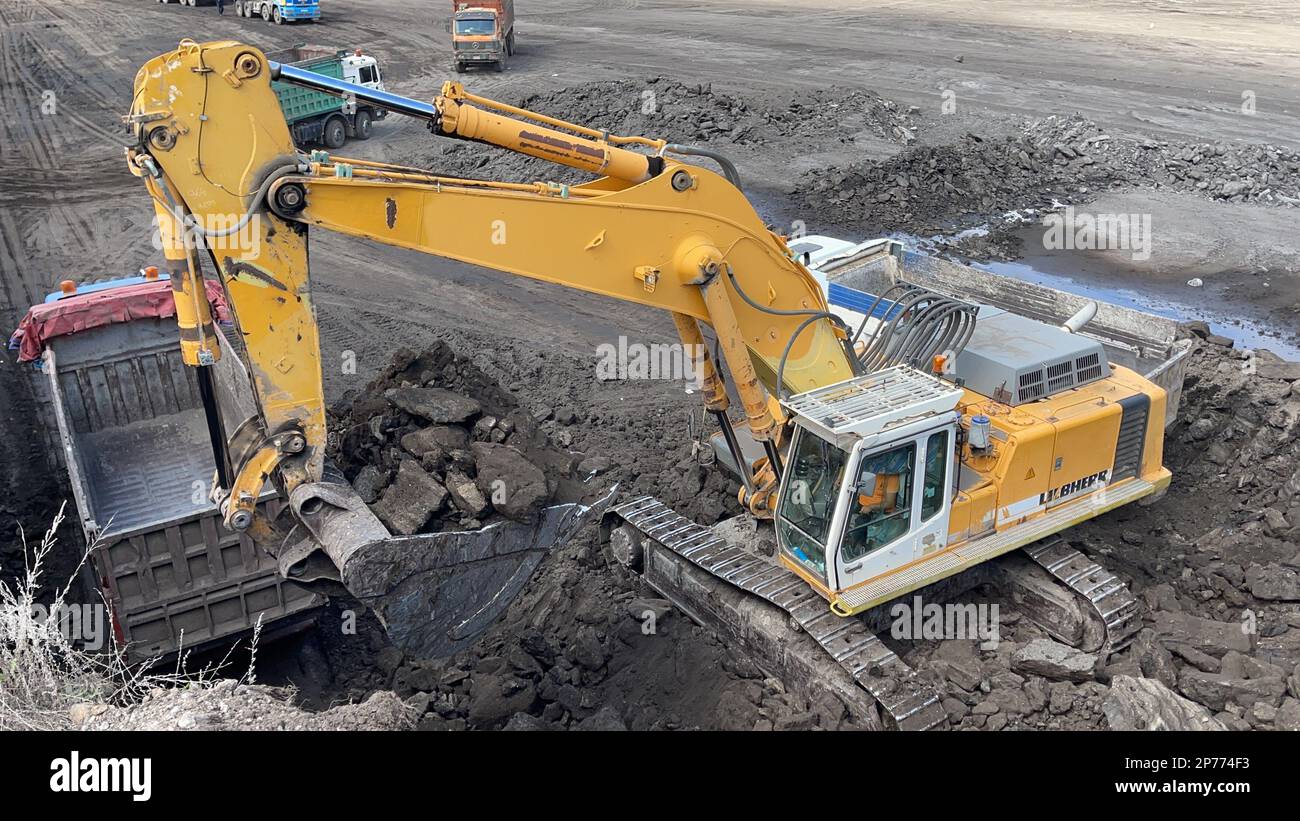 Excavator Working On Huge Mining Site, Loading The Trucks, Trucks ...