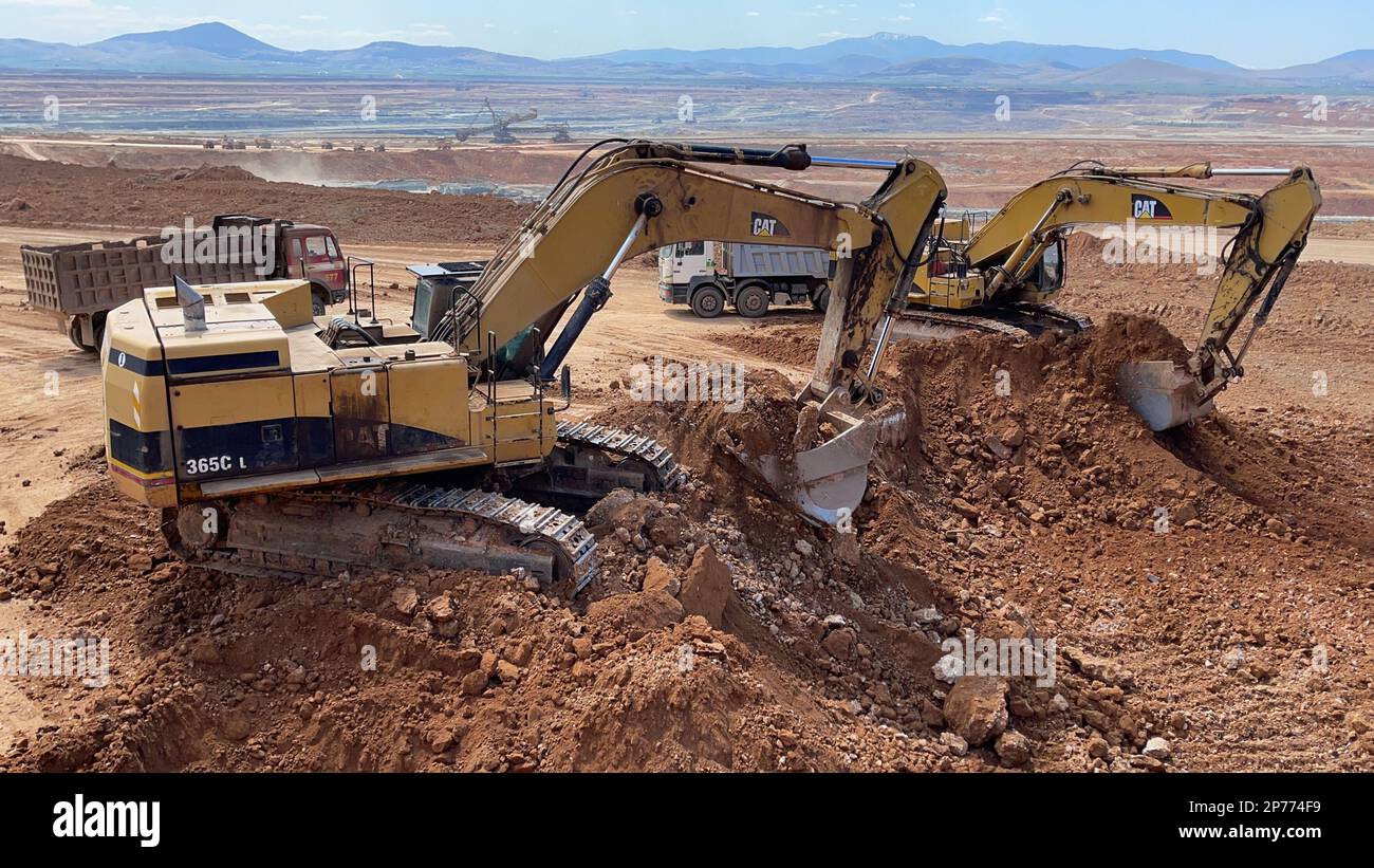 Excavators Working On Huge Mining Site, Loading The Trucks, Trucks ...