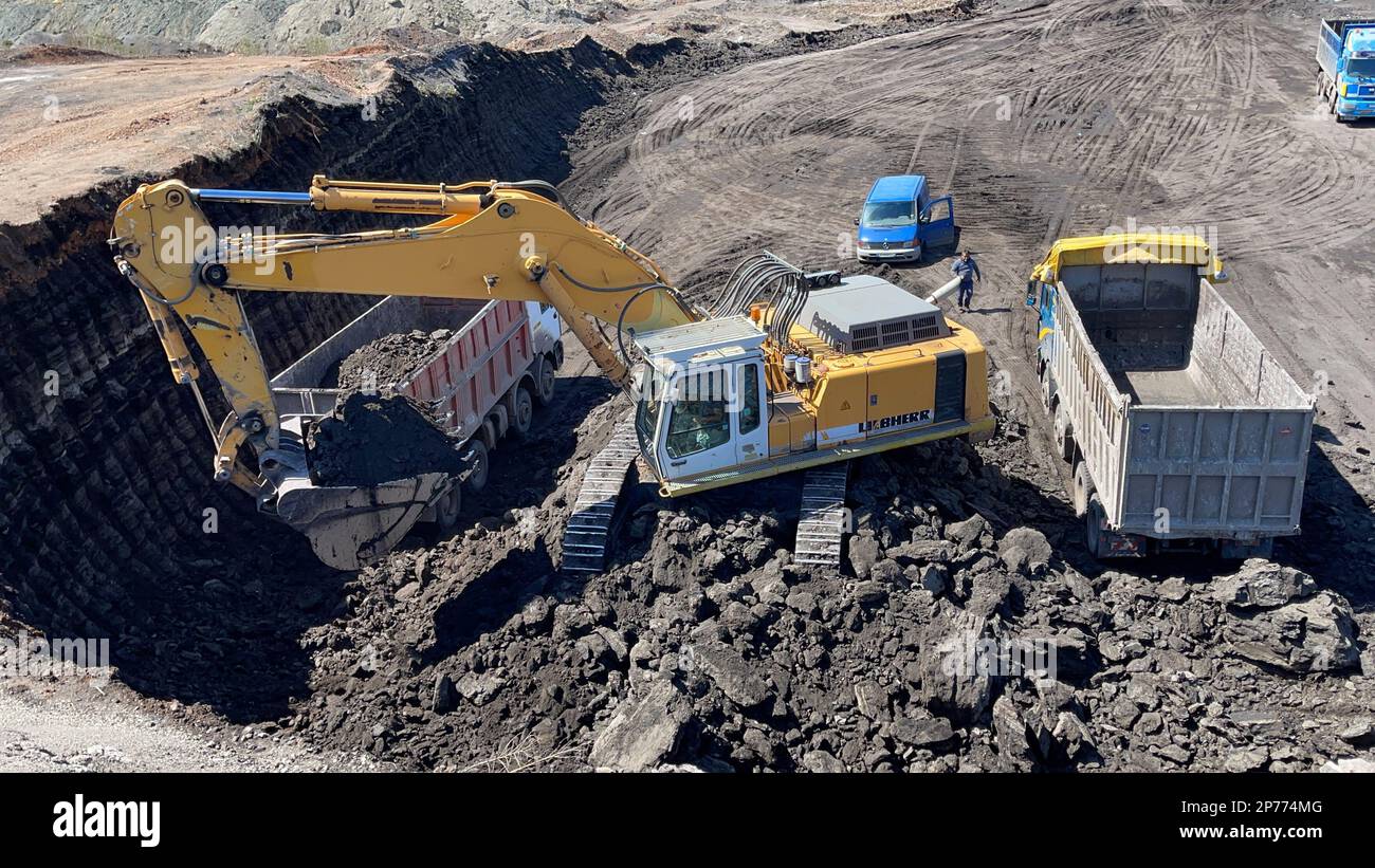 Excavator Working On Huge Mining Site, Loading The Trucks, Trucks ...