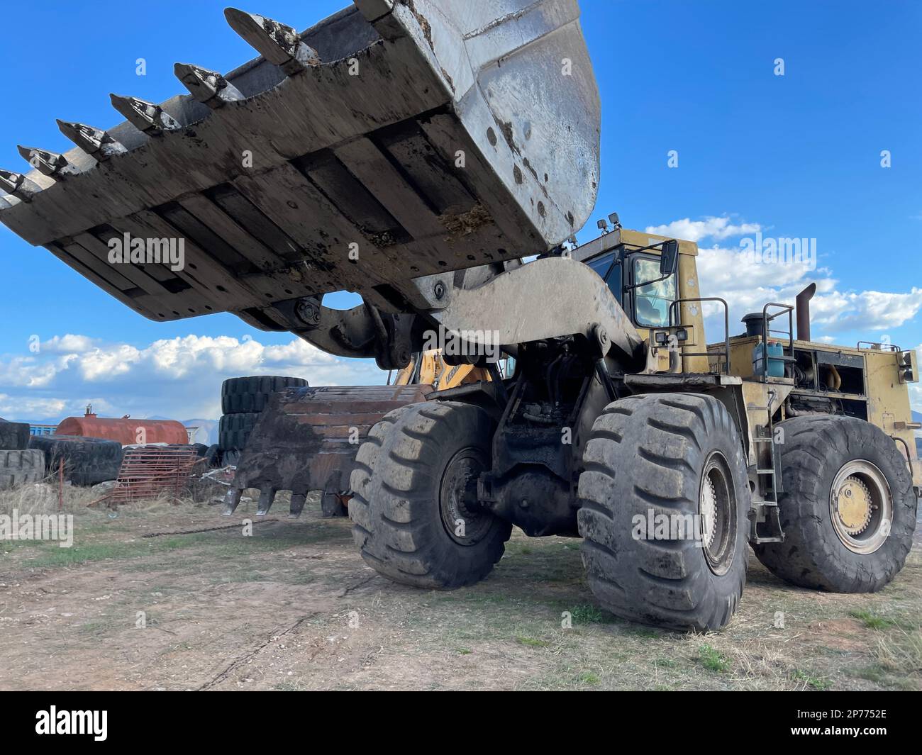 Wheel Loader loading soil on trucks, working at a huge mining site ...