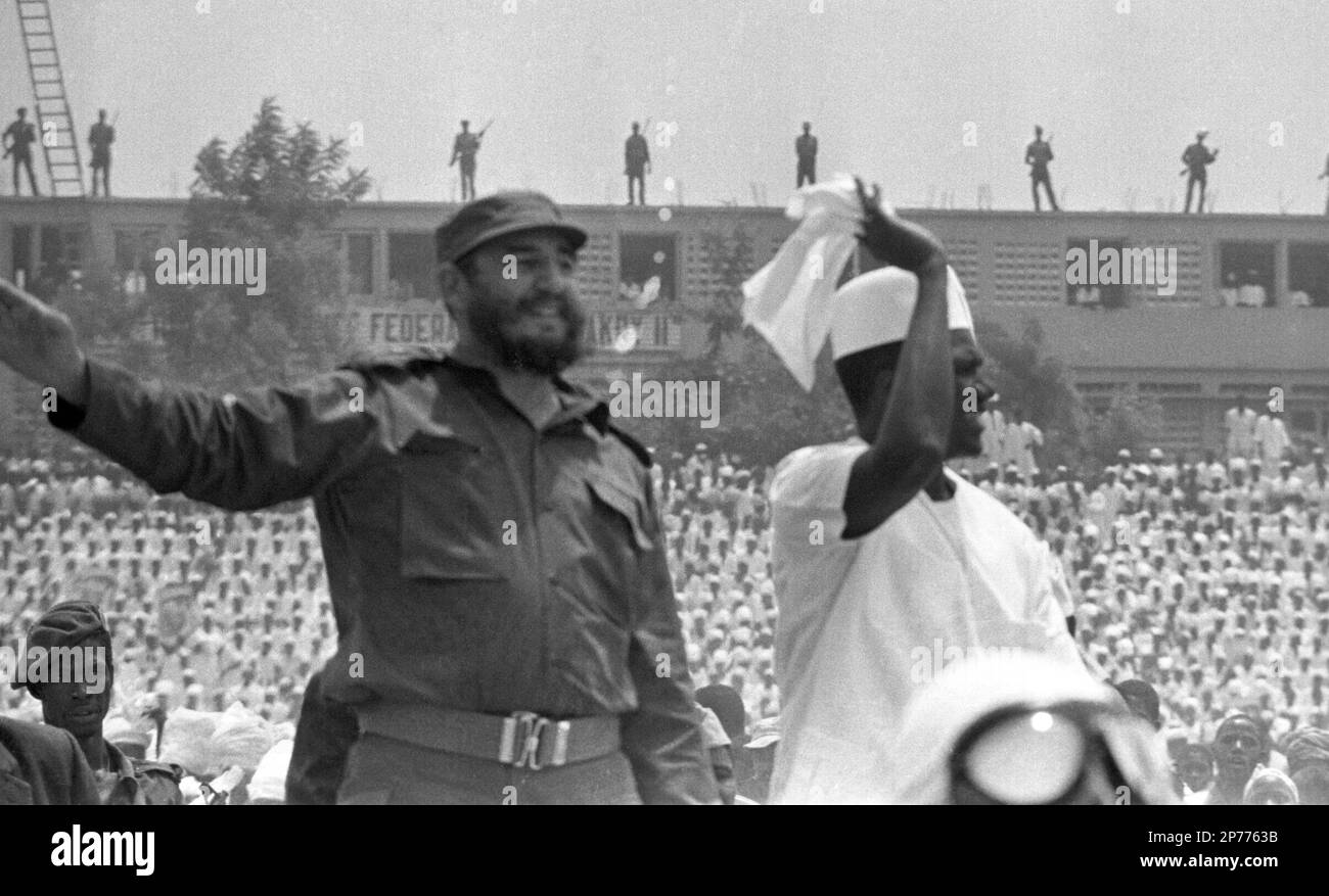 Cuban leader Fidel Castro, left, waves from an open car greeting the ...