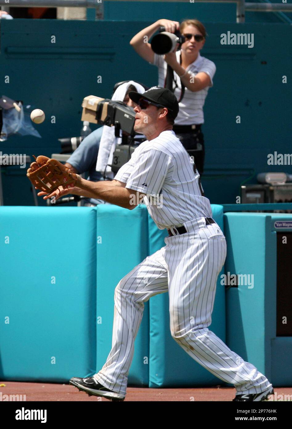 Florida Marlins' Greg Dobbs catches a popout by Los Angeles Dodgers ...