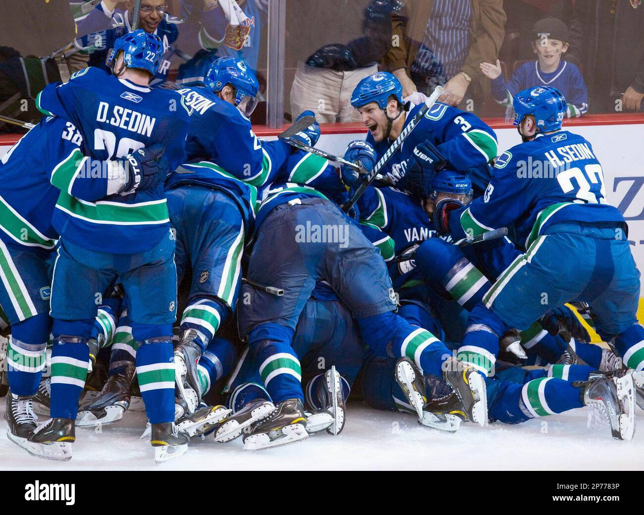 The Vancouver Canucks celebrate Alex Burrows game winning goal during ...