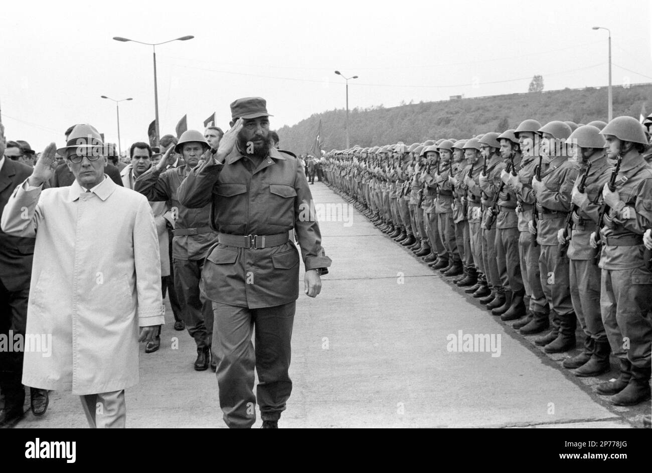 Cuban leader Fidel Castro, center left, reviews troops during his visit ...