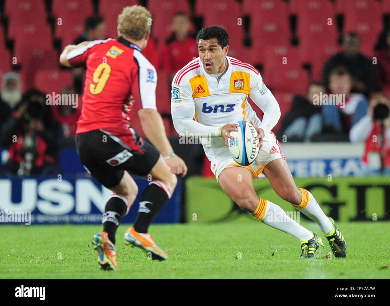 Mils Muliaina, right, of the New Zealand Chiefs sidesteps Jano Vermaak ...
