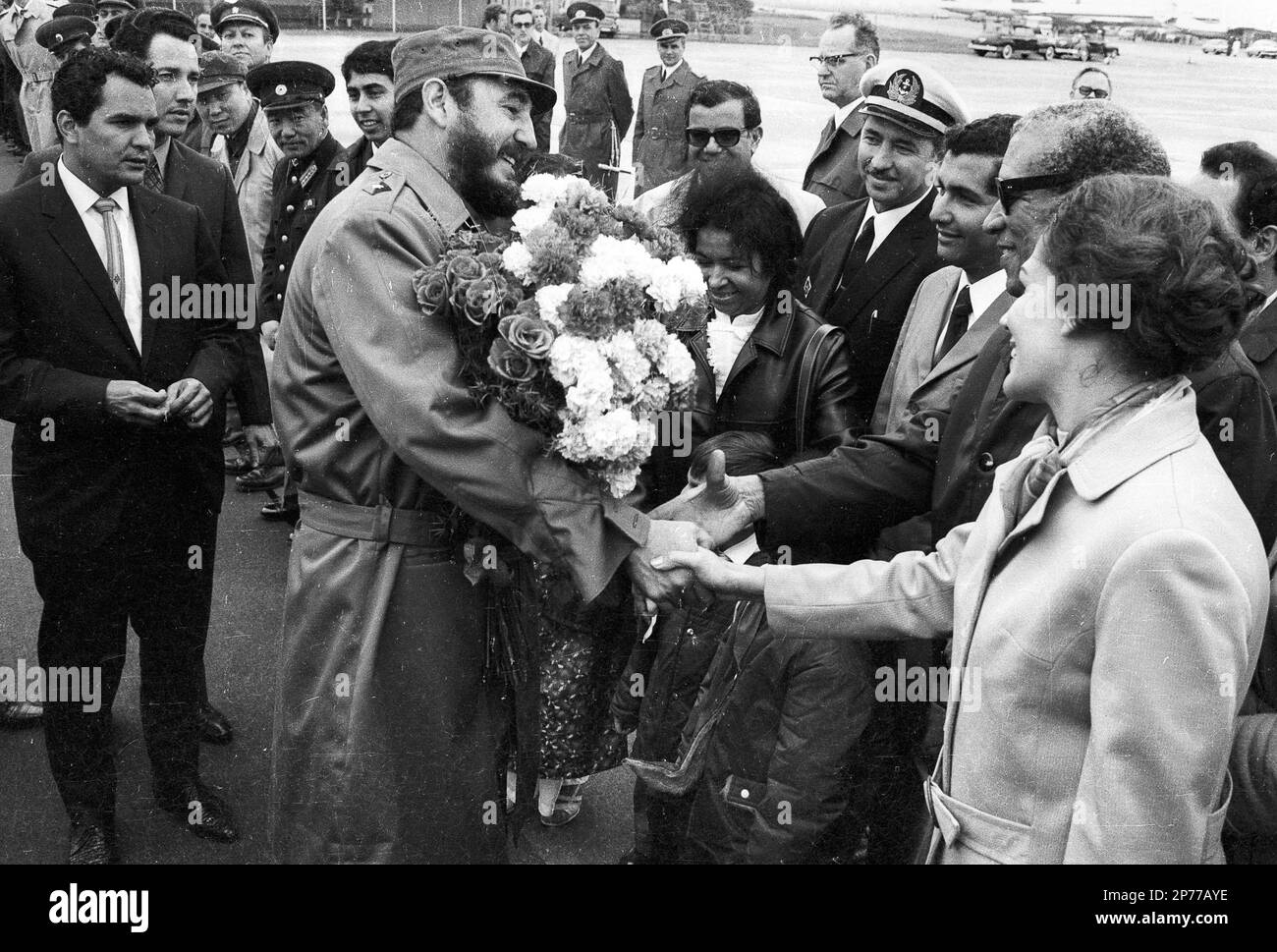 Holding a bouquet of flowers Cuban leader Fidel Castro is greeted at ...