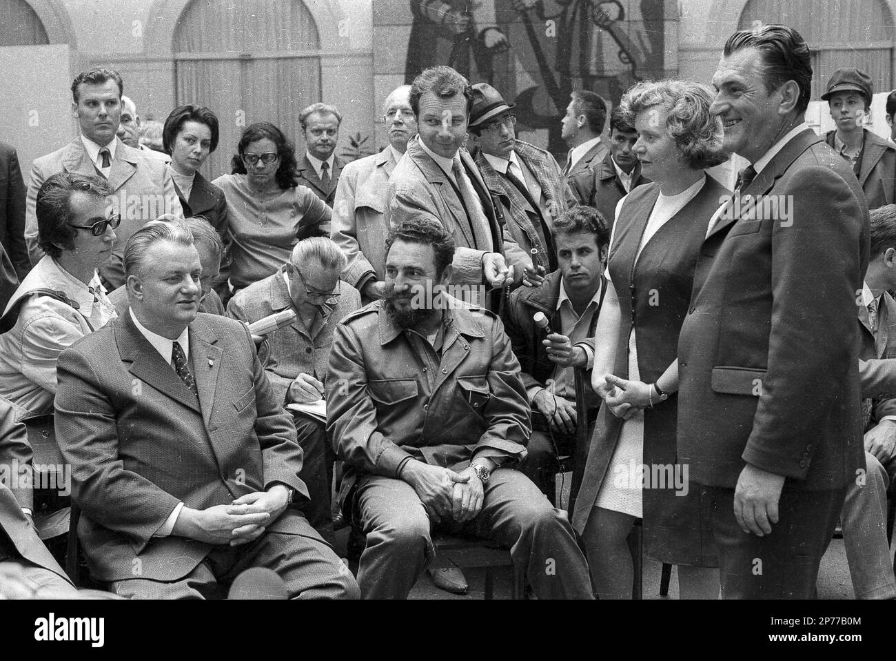 Cuban leader Fidel Castro, center, sits as he smiles during a visit to ...
