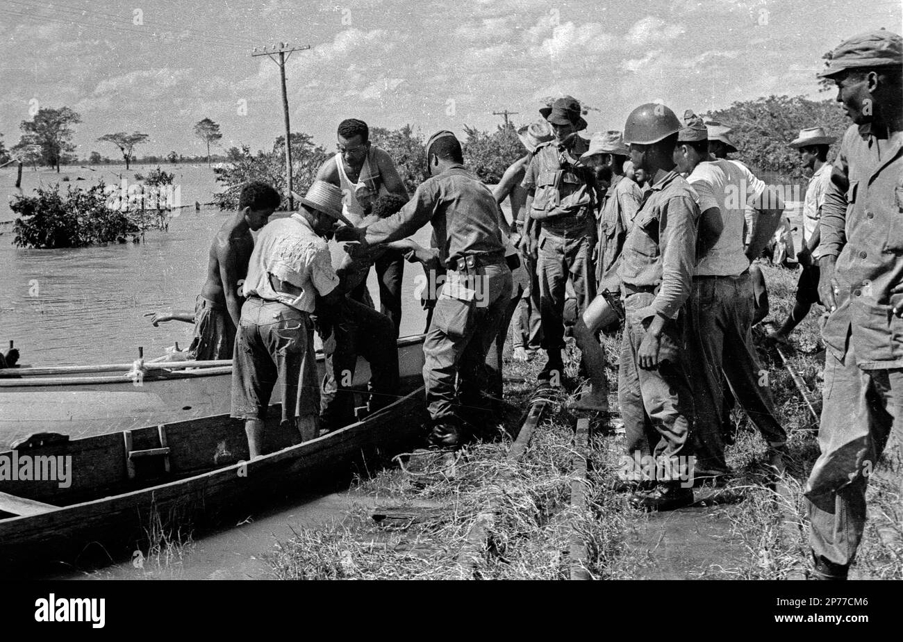 Soldiers of the Revolutionary Armed Forces in Cuba help a man off a ...