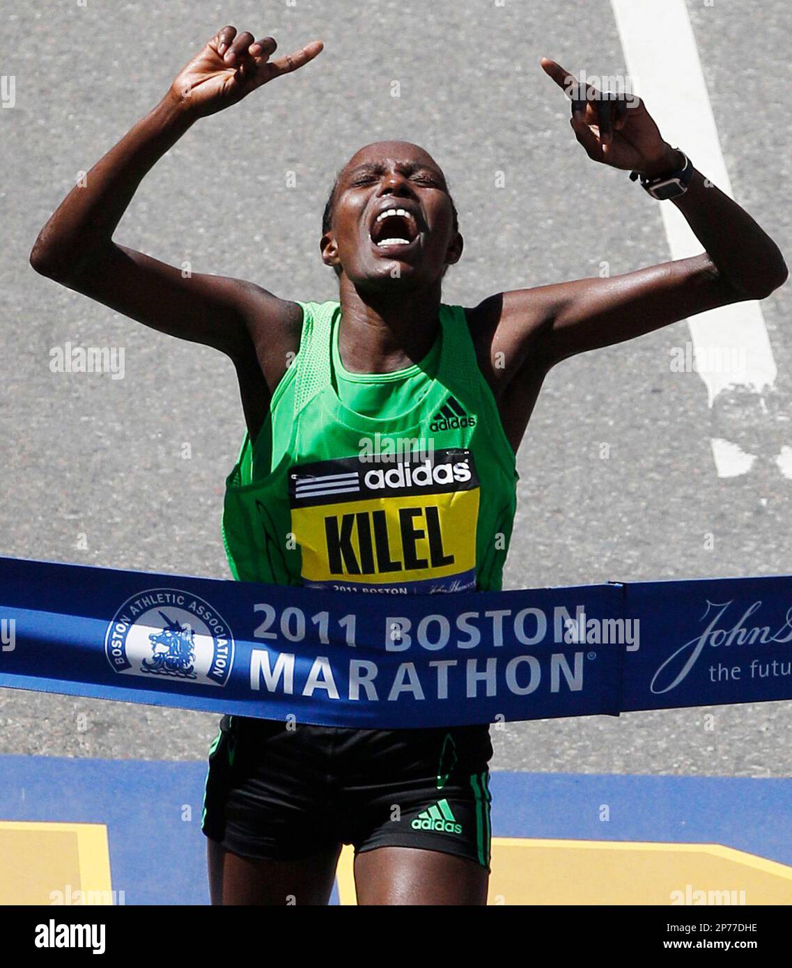 Caroline Kilel of Kenya reacts as she hits the tape at the finish line ...
