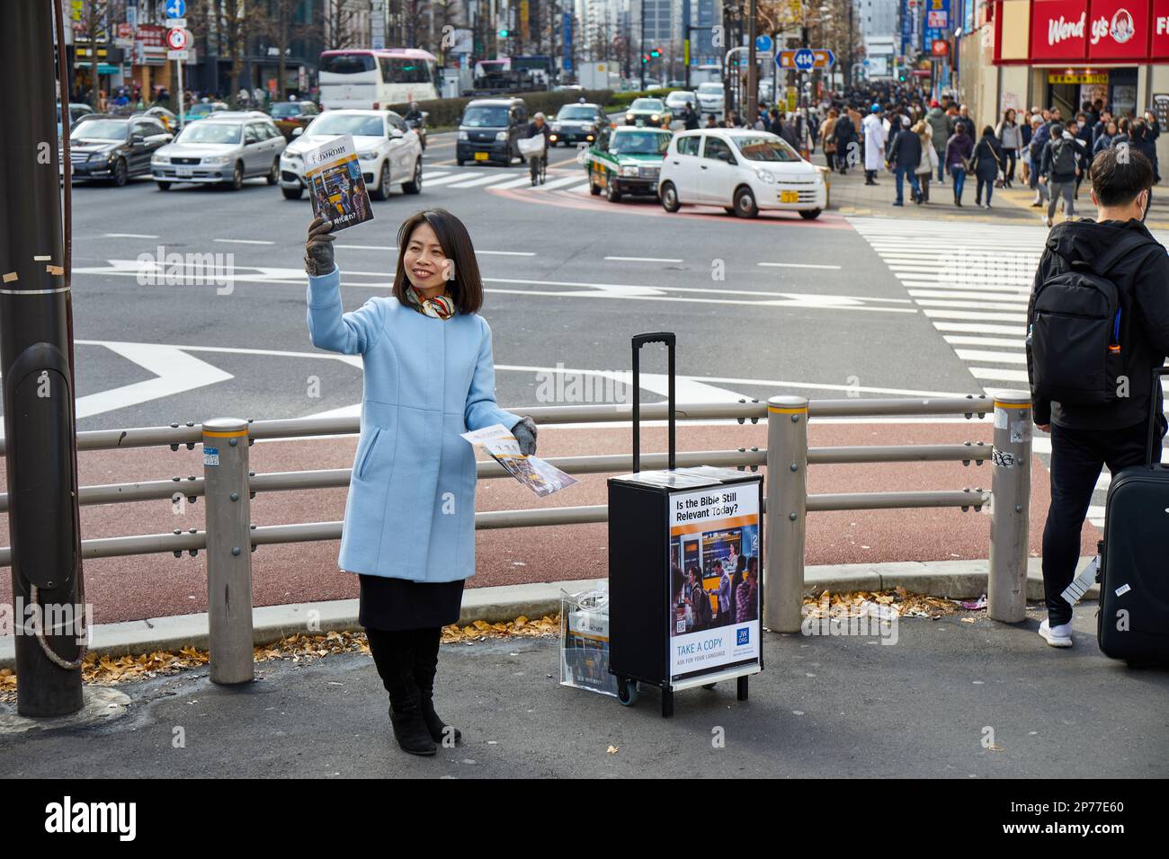 Jehovah's Witnesses; woman handing out copies of The Watchtower on ...
