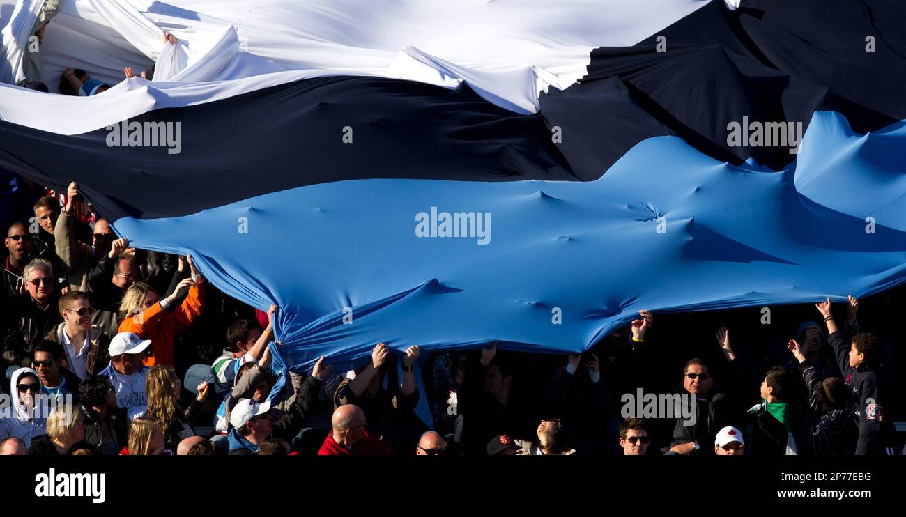 Vancouver Whitecaps fans pass a flag through the crowd as the team ...