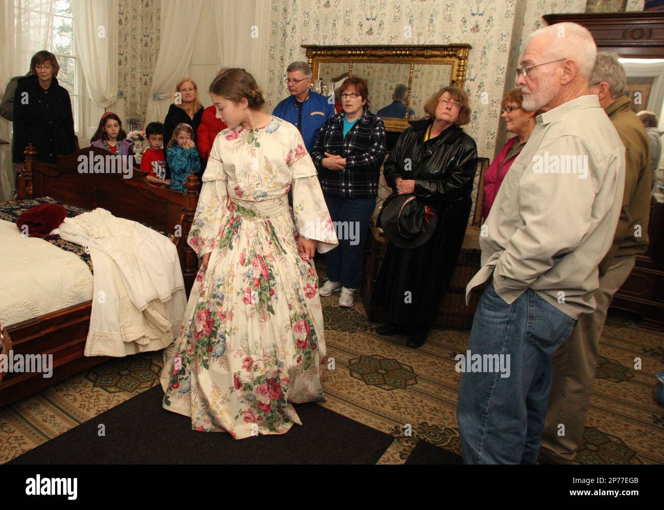Sydney Ash, portraying first lady Harriet Lane, talks to guests at ...