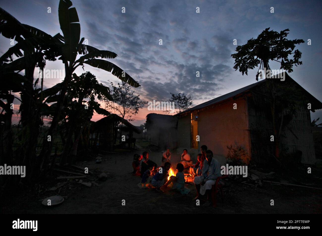In this Feb. 19, 2011 photo, a family sits around a bonfire outside ...