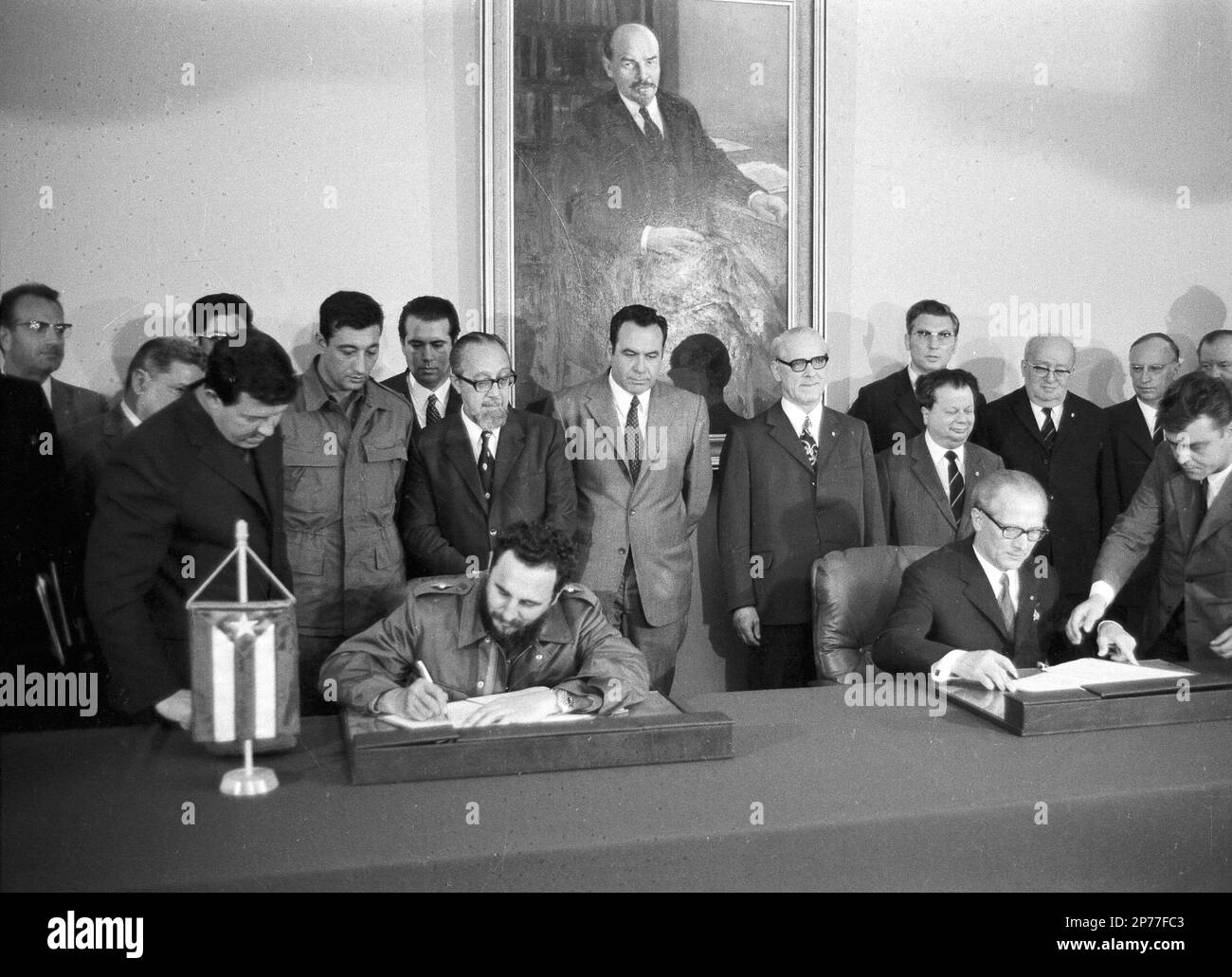 Cuban leader Fidel Castro, seated center, left, signs a bilateral ...