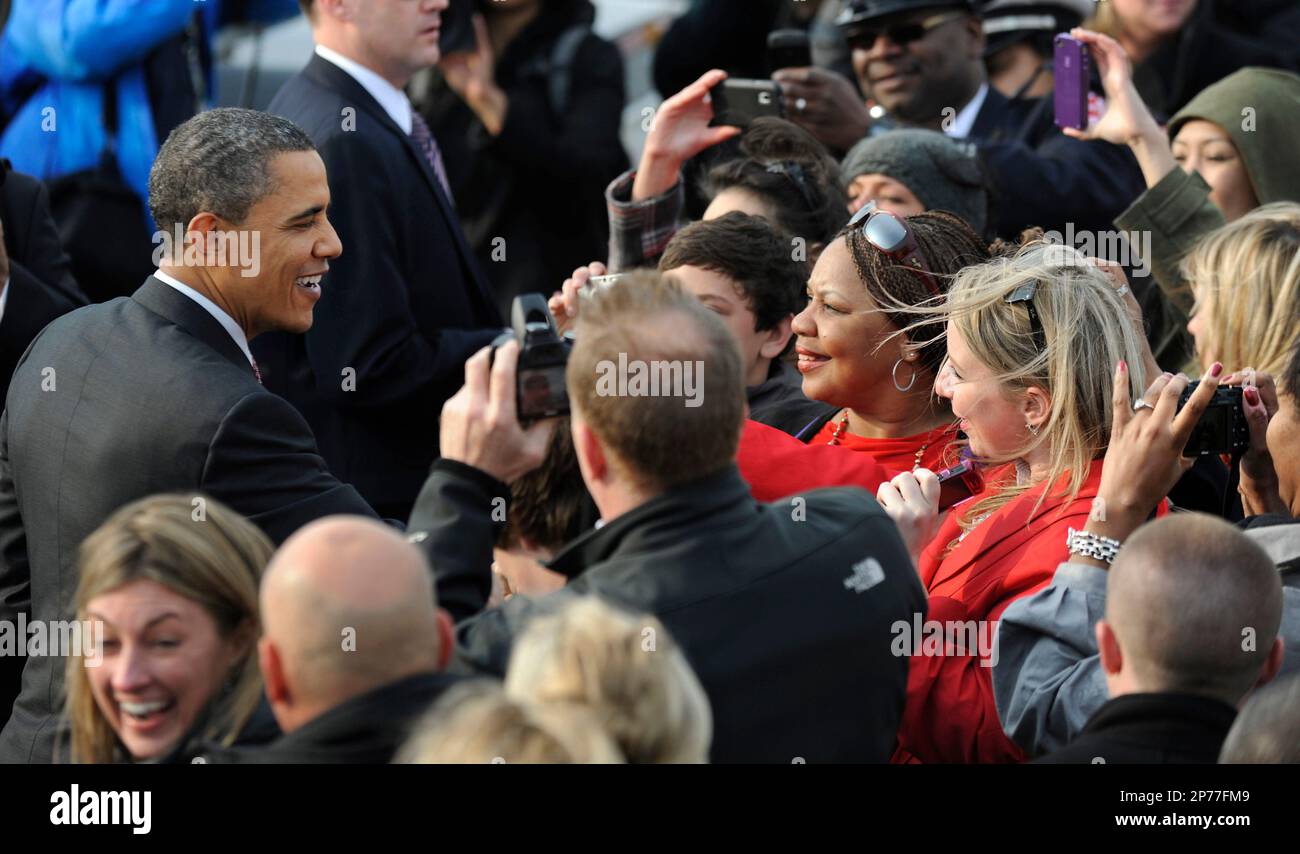 President Barack Obama greets a small crowd after arriving at Chicago O ...