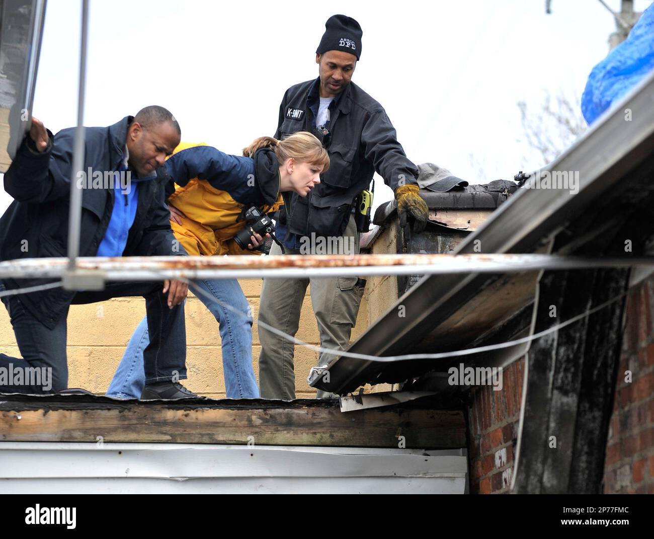 From left, two unidentified ATF agents and an unidentified Detroit fire ...