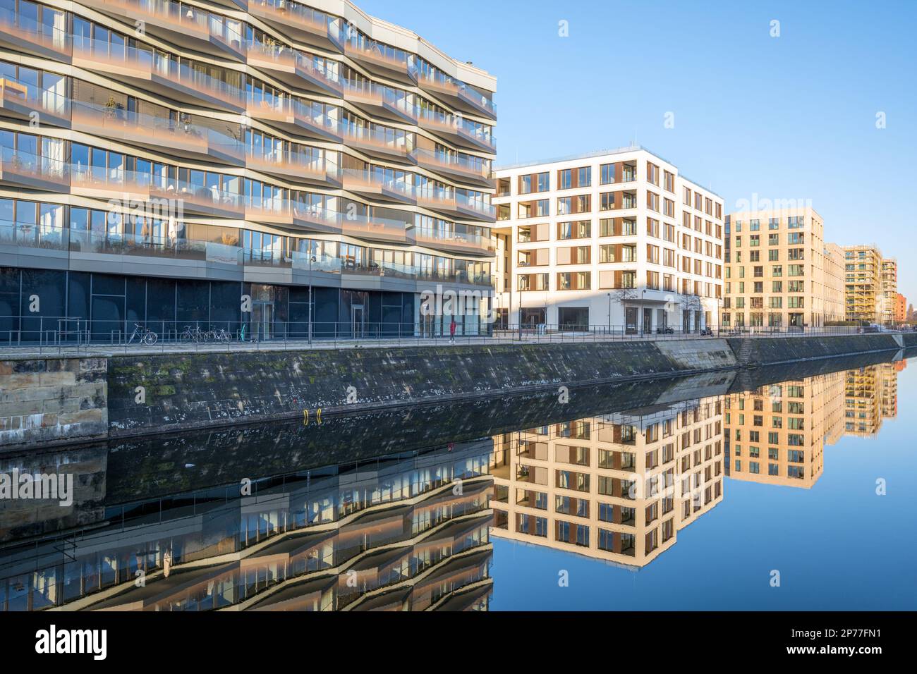 Modern apartment buildings in Berlin with a reflection in a small canal ...