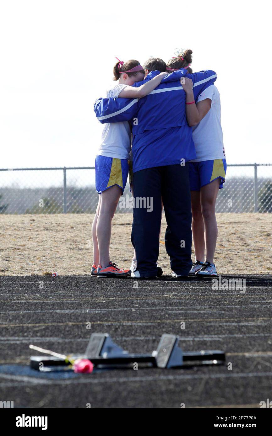 Buckley, Mich, High School track coach Ken Wicker hugs Haley Morairty ...