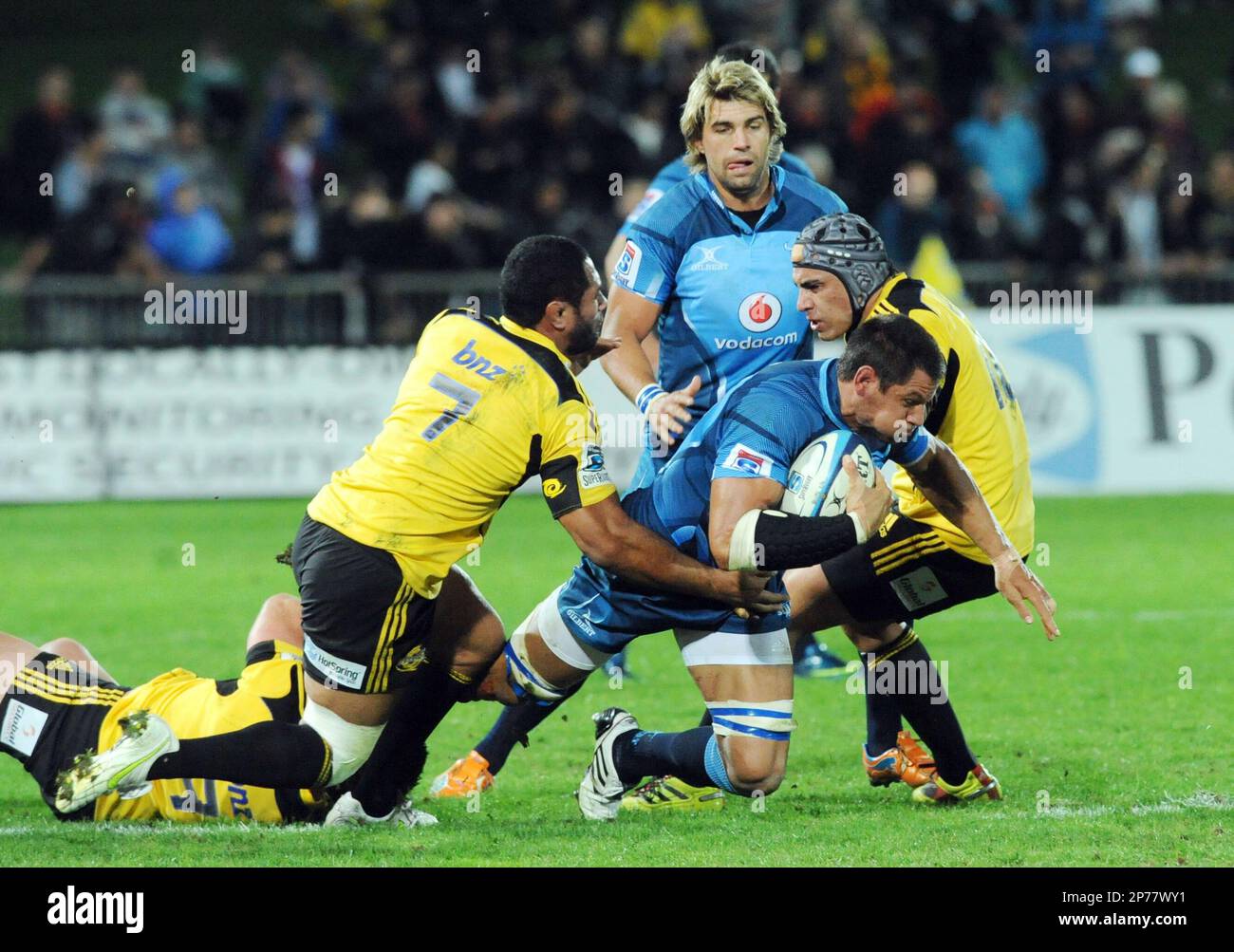 Bulls' Pierre Spies busts through the Hurricane defense of Serge Lilo ...