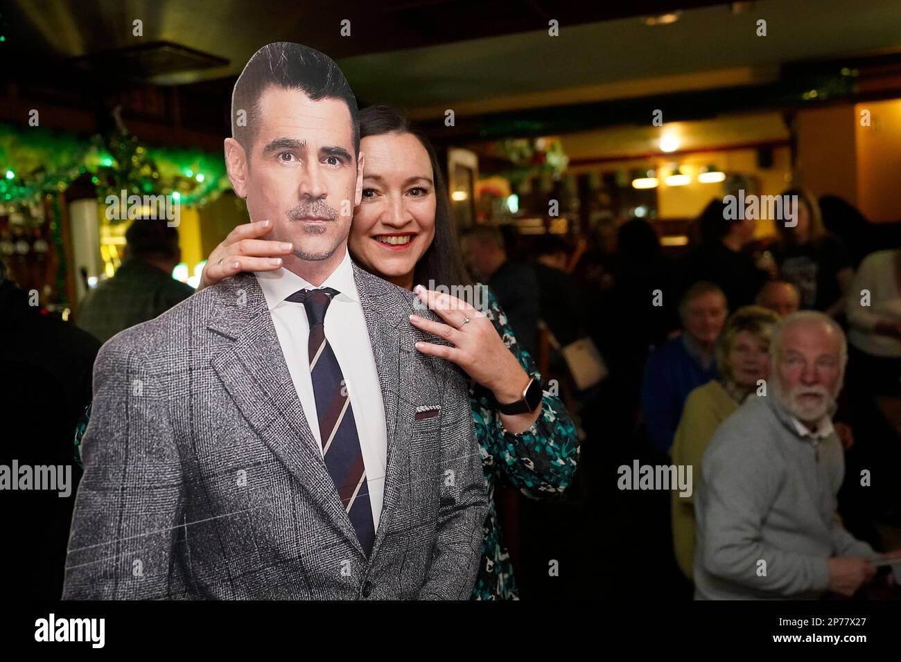 Customers in McLoughlin's Bar pose with a cut out of Colin Farrell ...