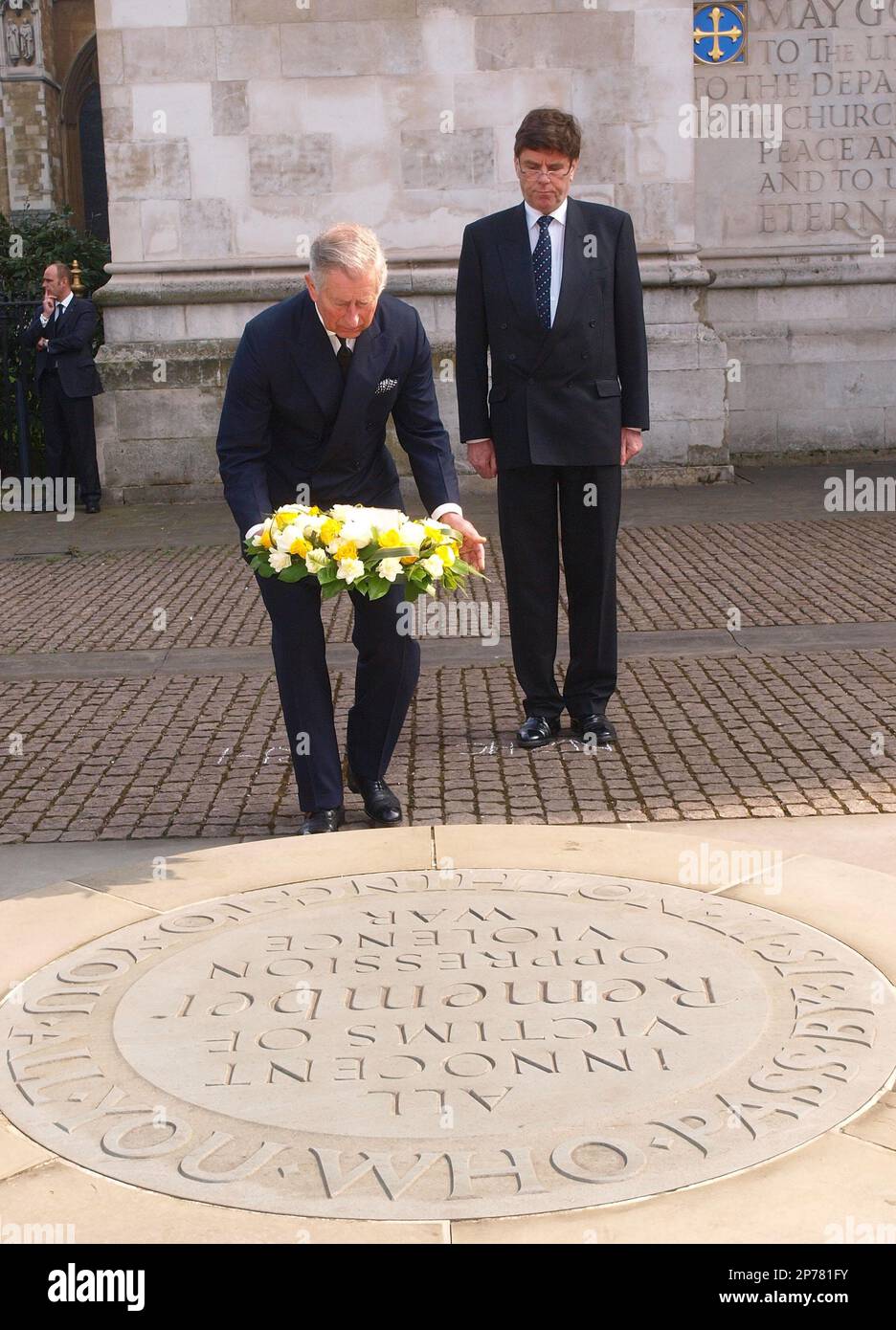 Prince Charles, Prince of Wales, lays a wreath watched by New Zealand ...