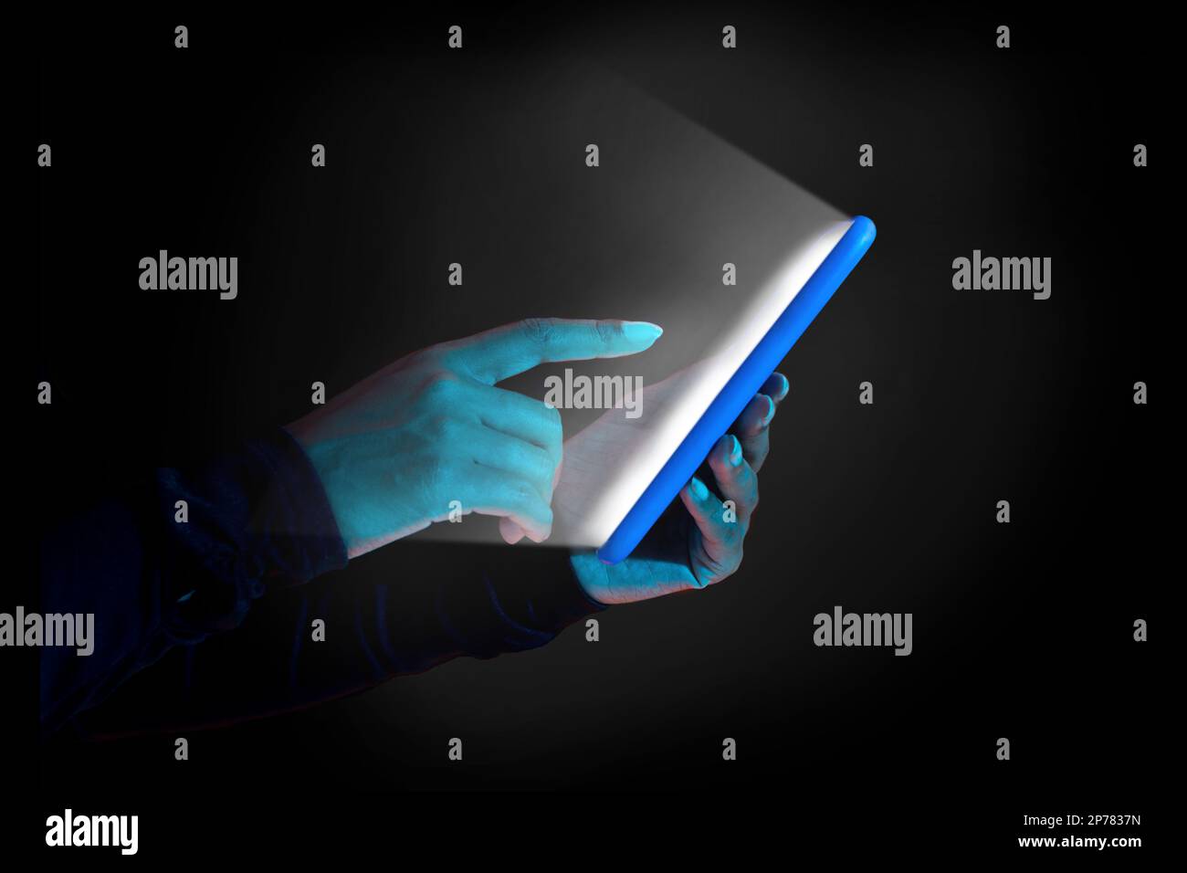 Woman holding smartphone with glowing white screen on dark background ...