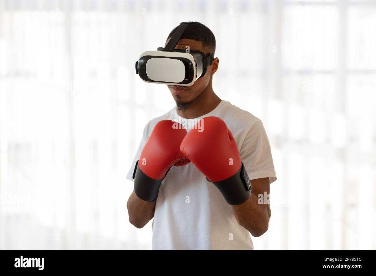 Athletic young black man in VR glasses and boxing gloves Stock Photo ...