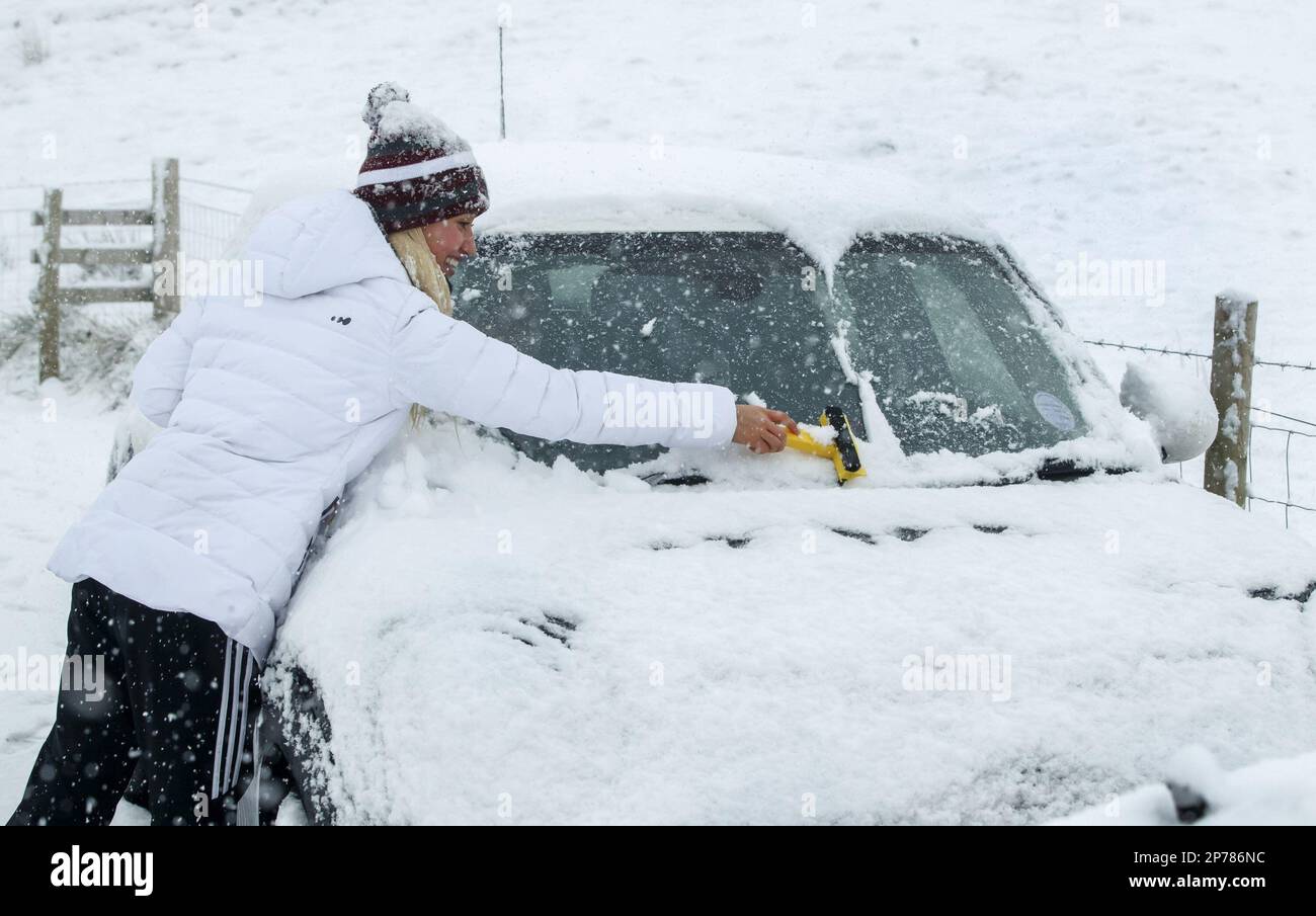 Handout photo of a snow being cleared from a windscreen See PA Feature ...