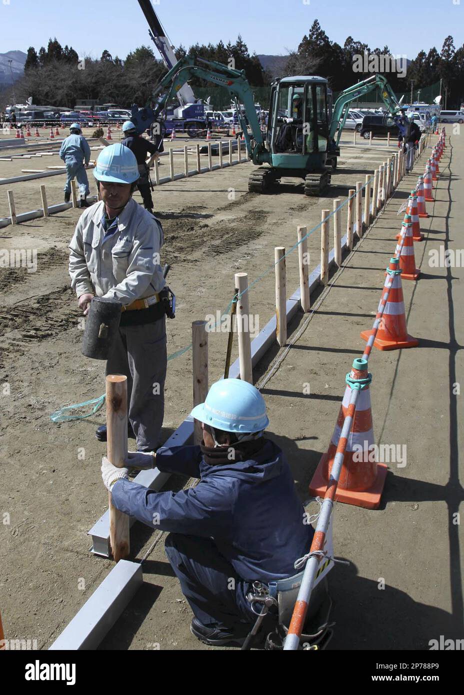 Workers start building temporary housing in Rikuzentakata, northern ...
