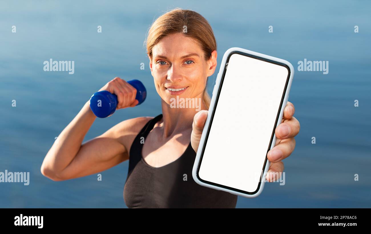 Sporty Middle Aged Woman Training With Dumbbells Outdoors And Showing ...