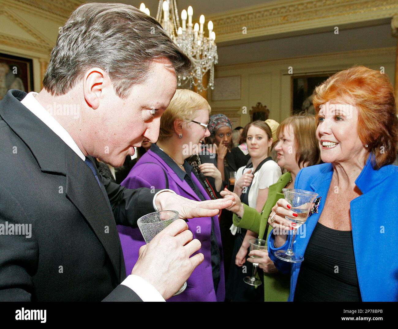 Britain's Prime Minister David Cameron, left, talks with British media ...