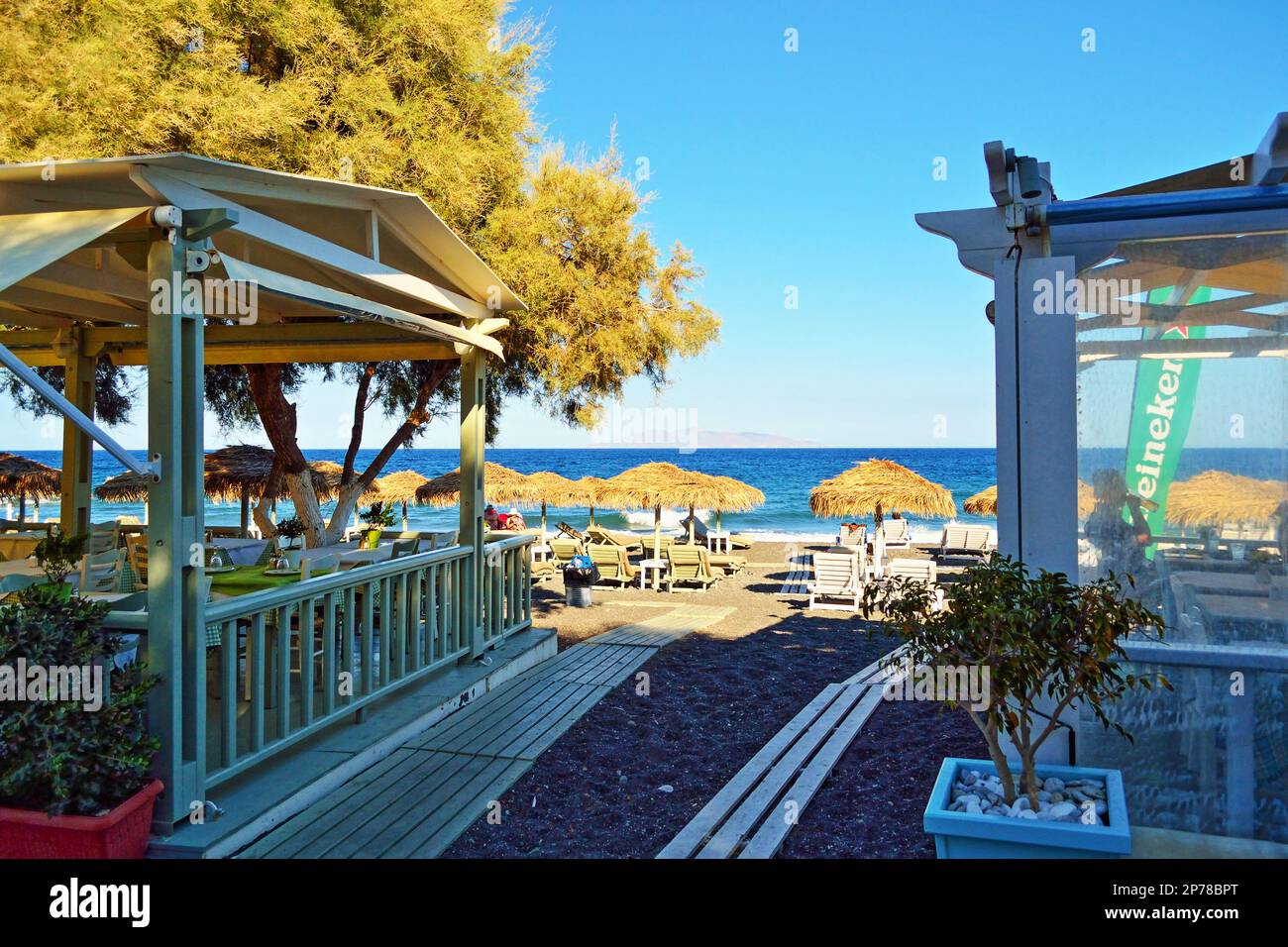 Nice outdoor restaurant seating on Kamari Black beach, Anafi island in ...
