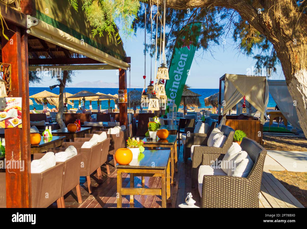 Nice outdoor restaurant seating on Kamari Black beach, Anafi island in ...