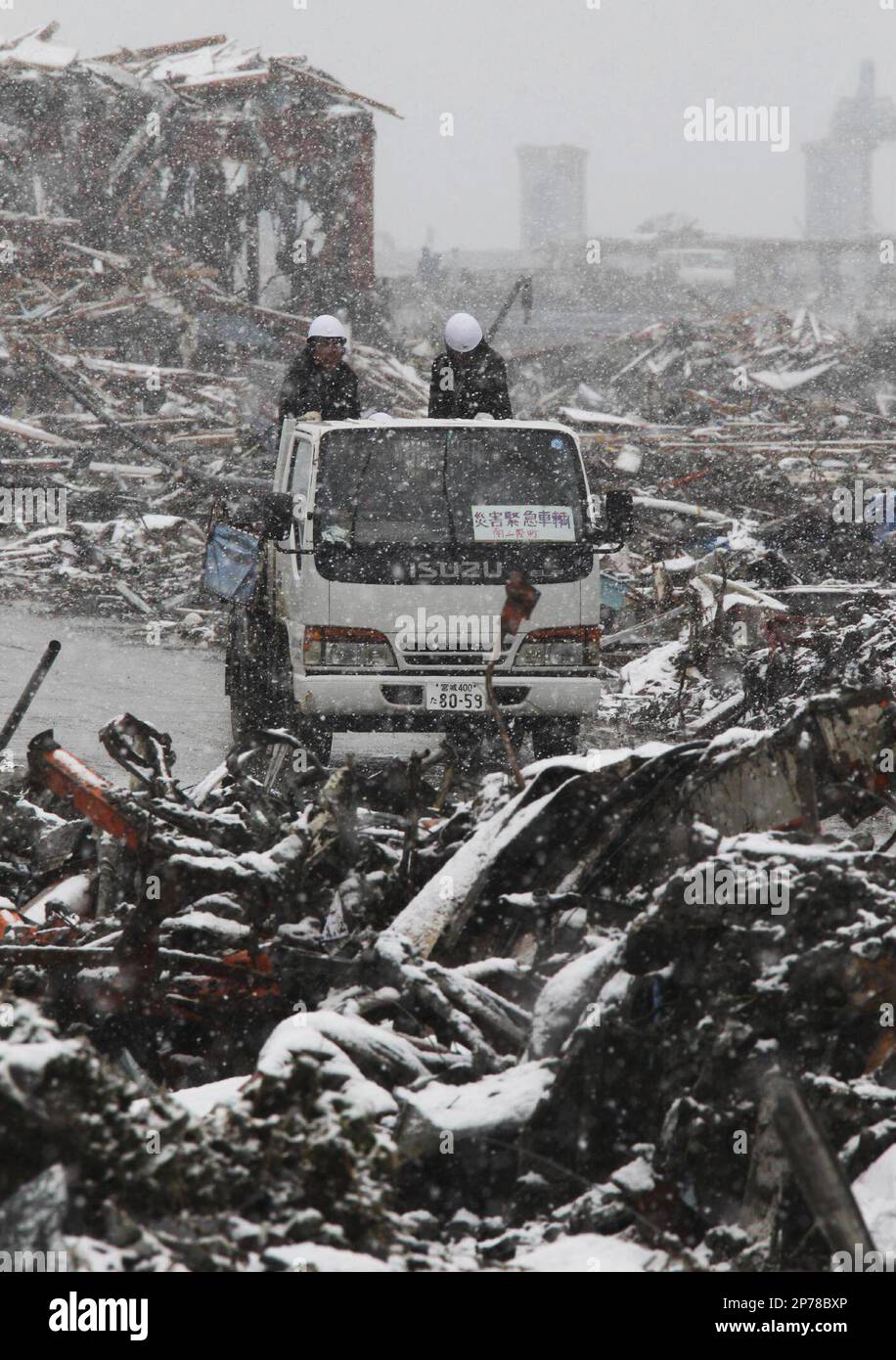 A disaster emergency vehicle drives through debris in Minamisanriku ...