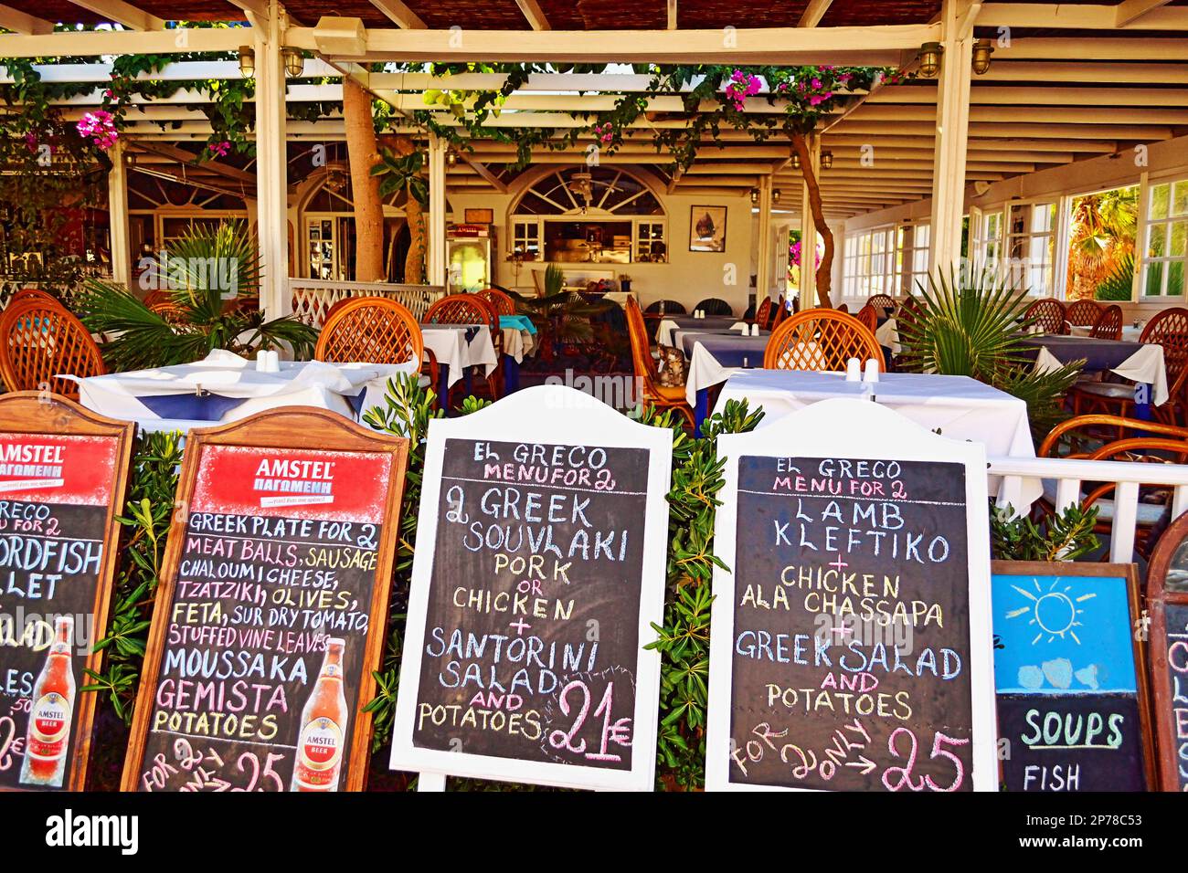 Menus at seaside restaurant in Kamari village,Santorini island,Greece ...