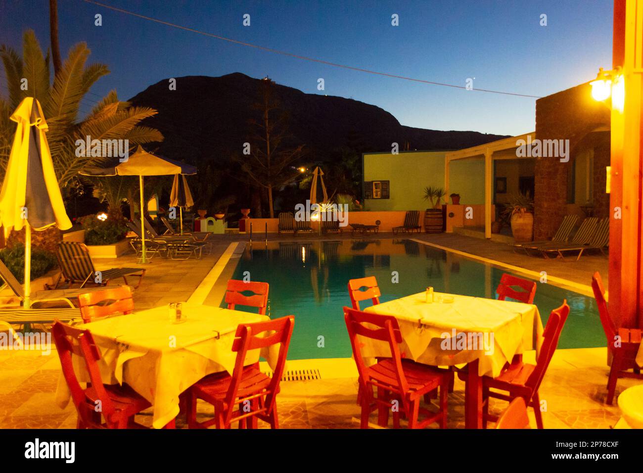 Night scene with traditional Santorini island villa with a pool and ...