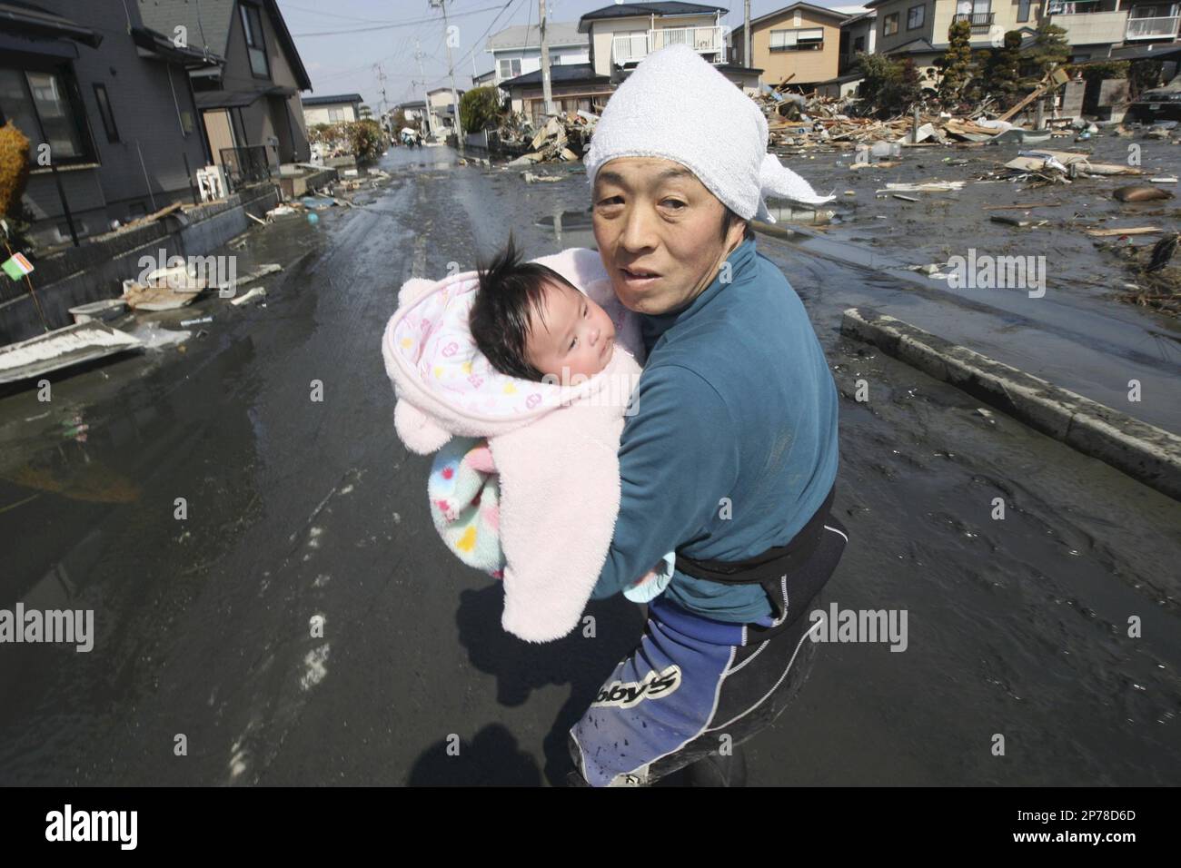 Upon hearing another tsunami warning, a father tries to flee for safety ...