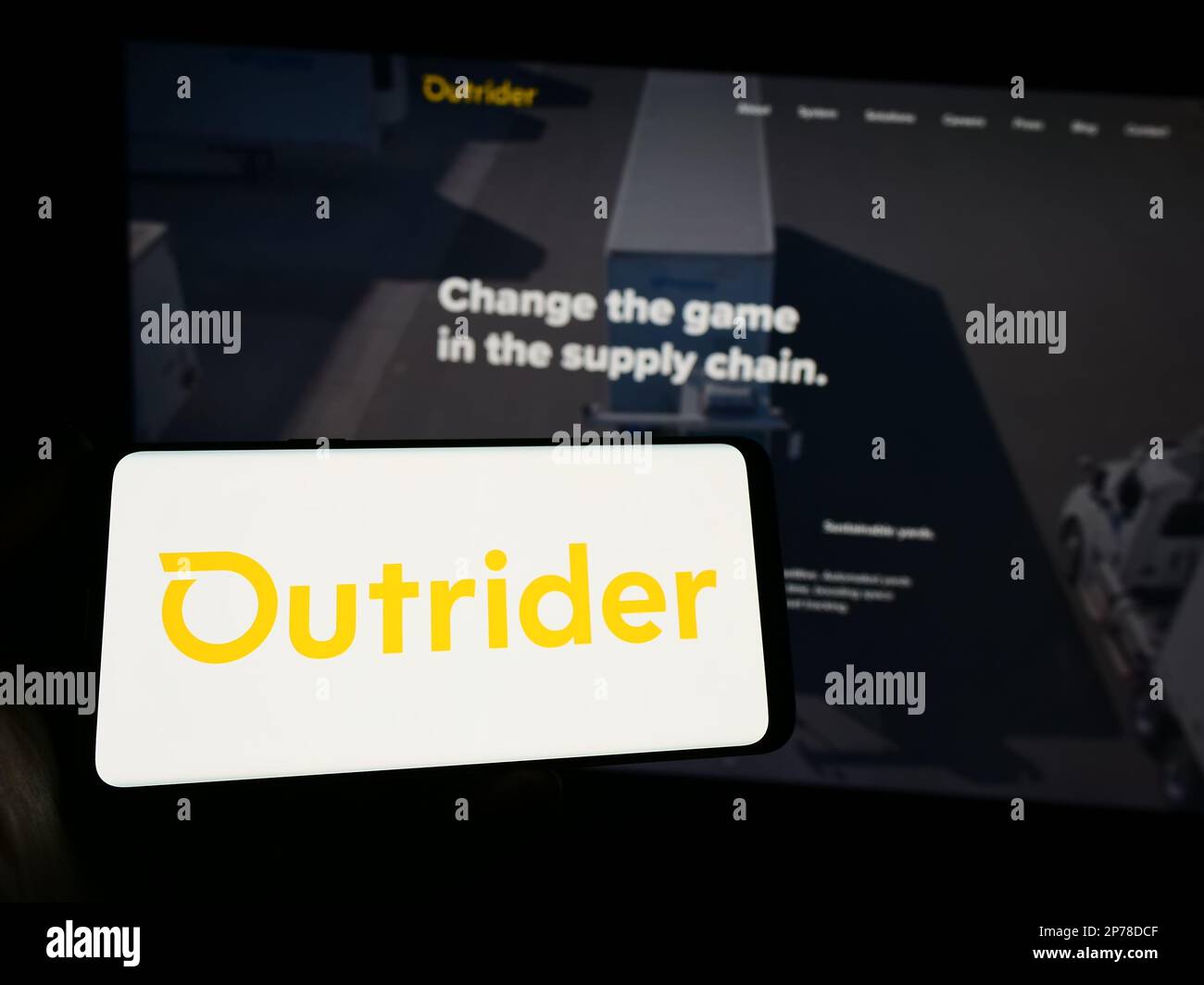 Person holding smartphone with logo of US company Outrider Technologies ...